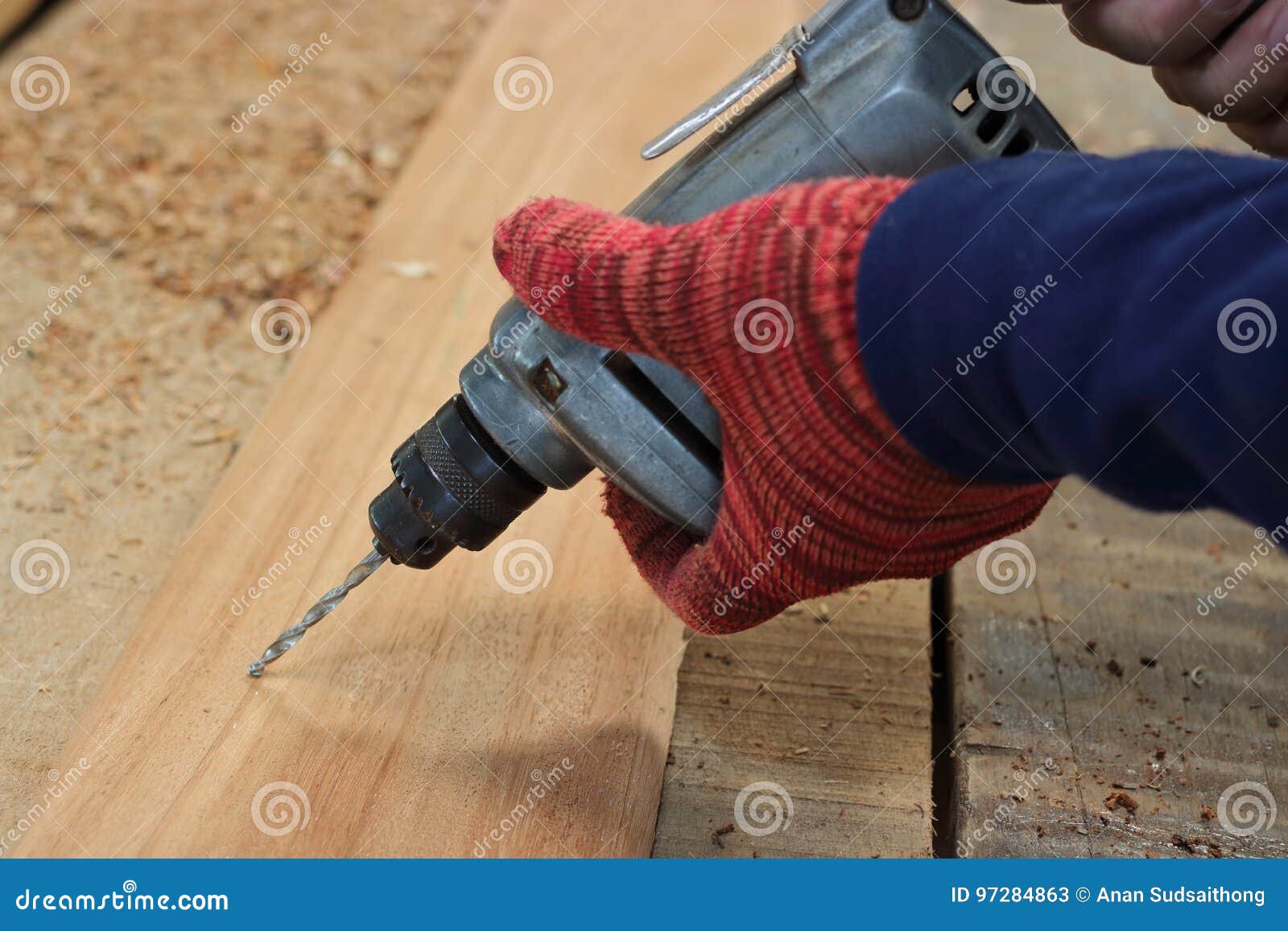 Hand of Worker Drills a Hole with Wooden Plank Using Electric Drill ...