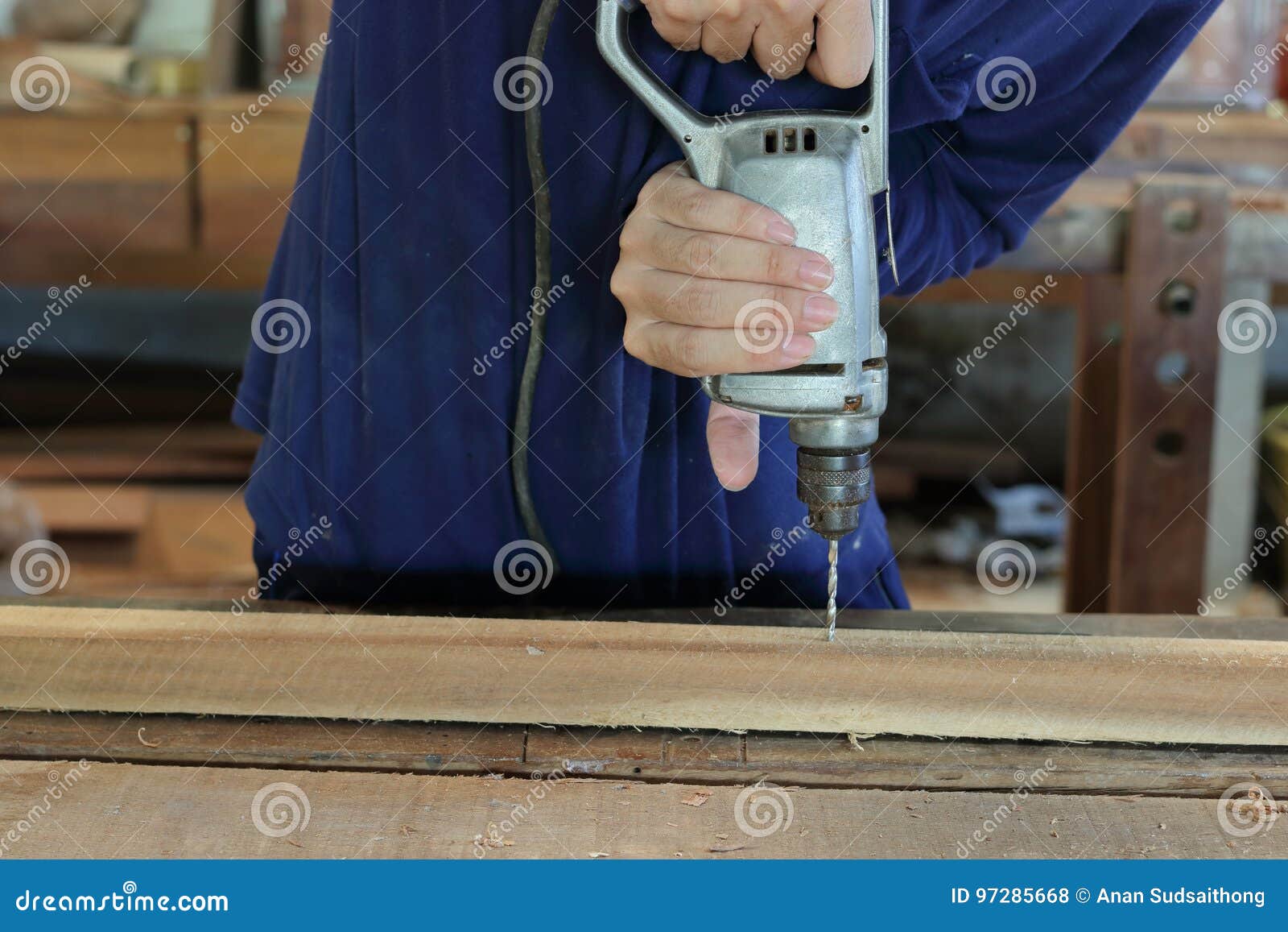 Hand of Worker Drills a Hole with Wooden Plank Using Electric Drill ...