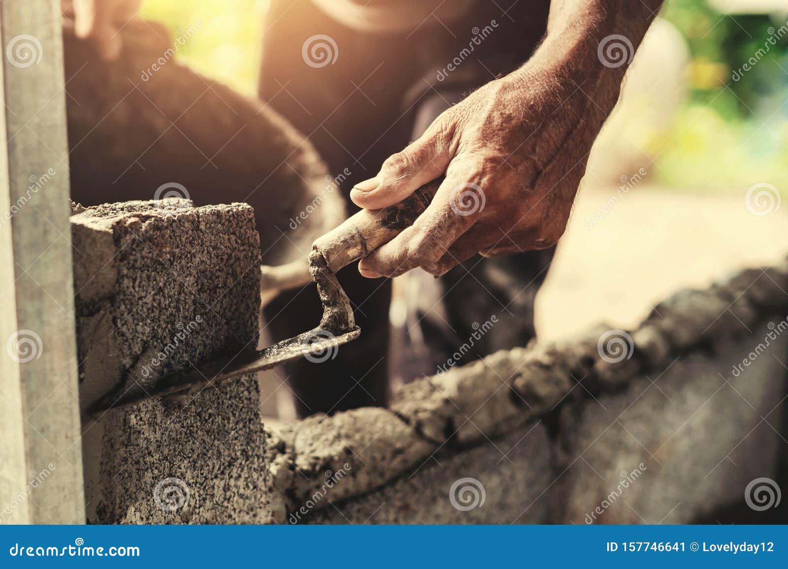 Hand of Worker Plastering Cement on Brick Wall at Construction Site ...