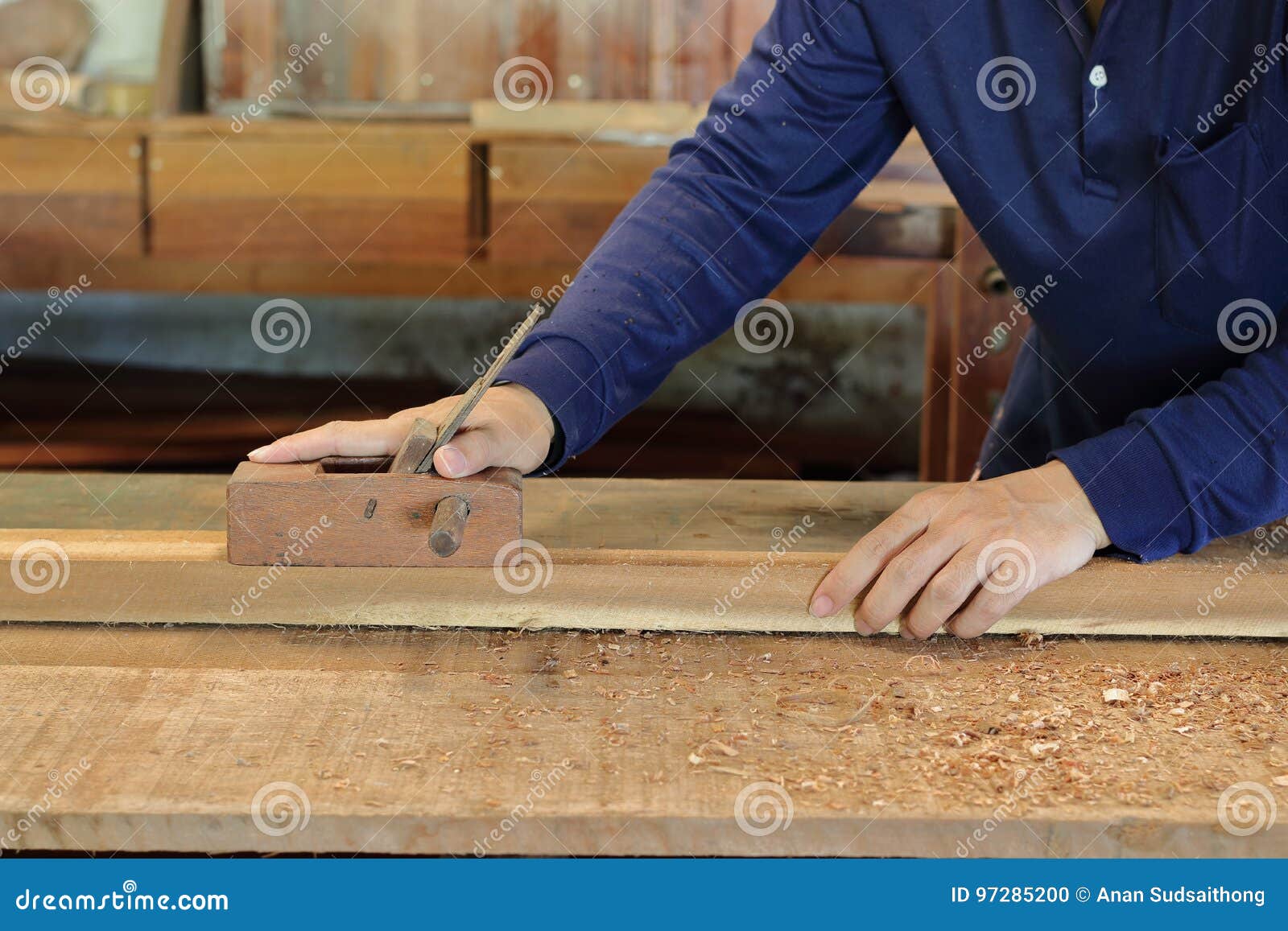 Hand of Worker Working with a Hand Planer on a Plank of Wood. Stock ...