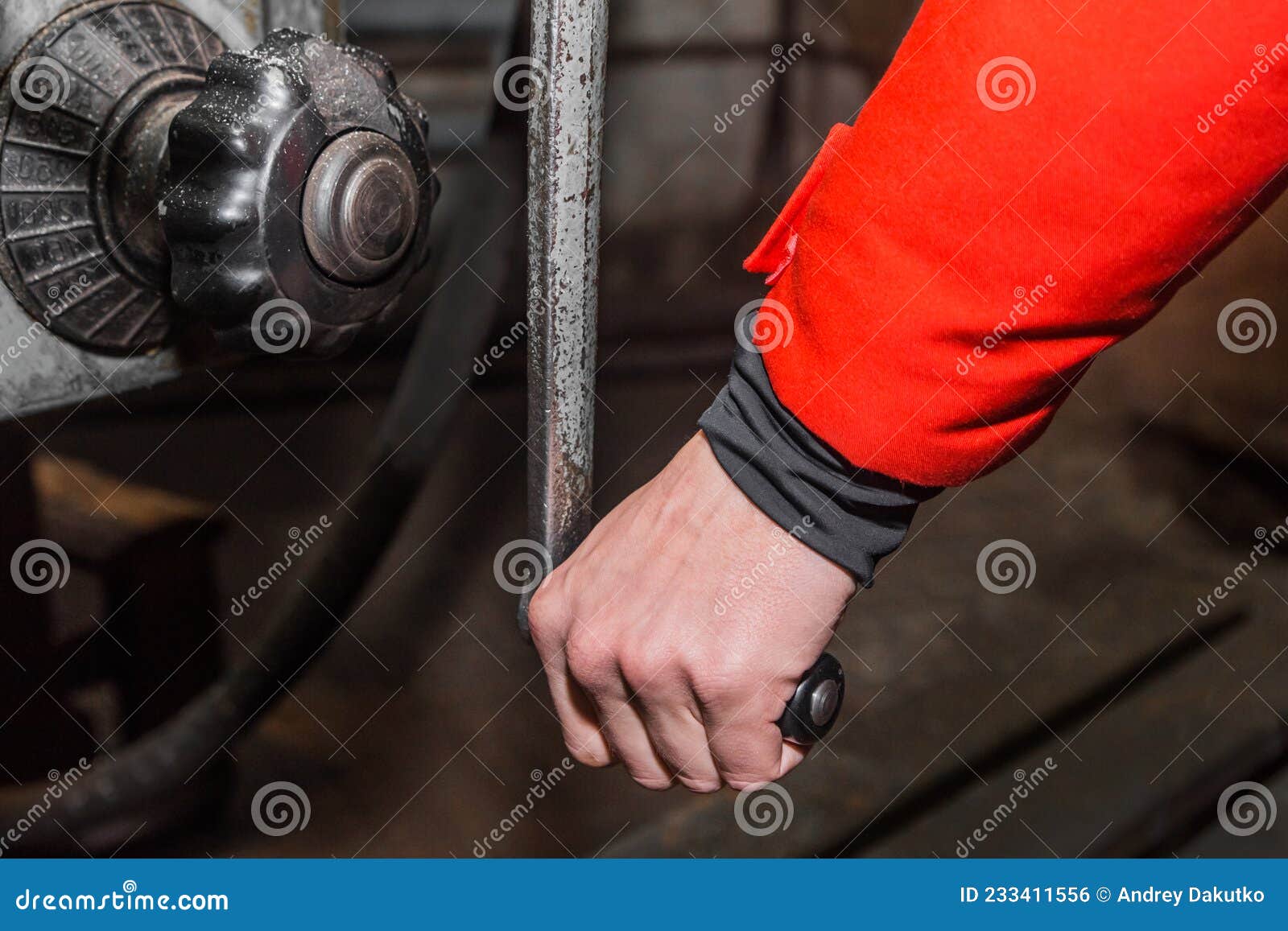 The Hand of a Working Man Holds the Handle and Controls the Work of the ...