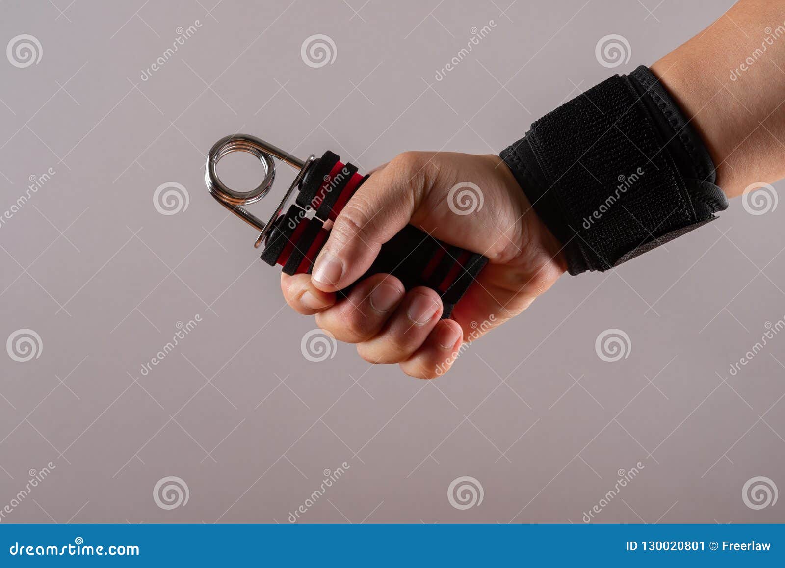 Hand with a Wrist Protective Strap Doing Exercises by Squeezing a Shape ...