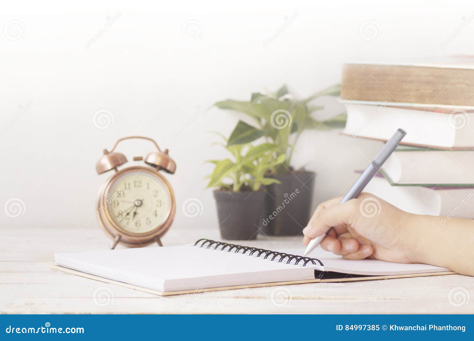 Hand Writing on Note Paper at Working Table with Alarm Clock Stock ... Hand Writing on Note Paper at Working Table with Alarm Clock Stock ...