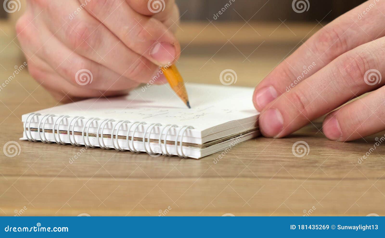 Hand Writing in a Notebook on Wooden Table. Close Up. Stock Image ...
