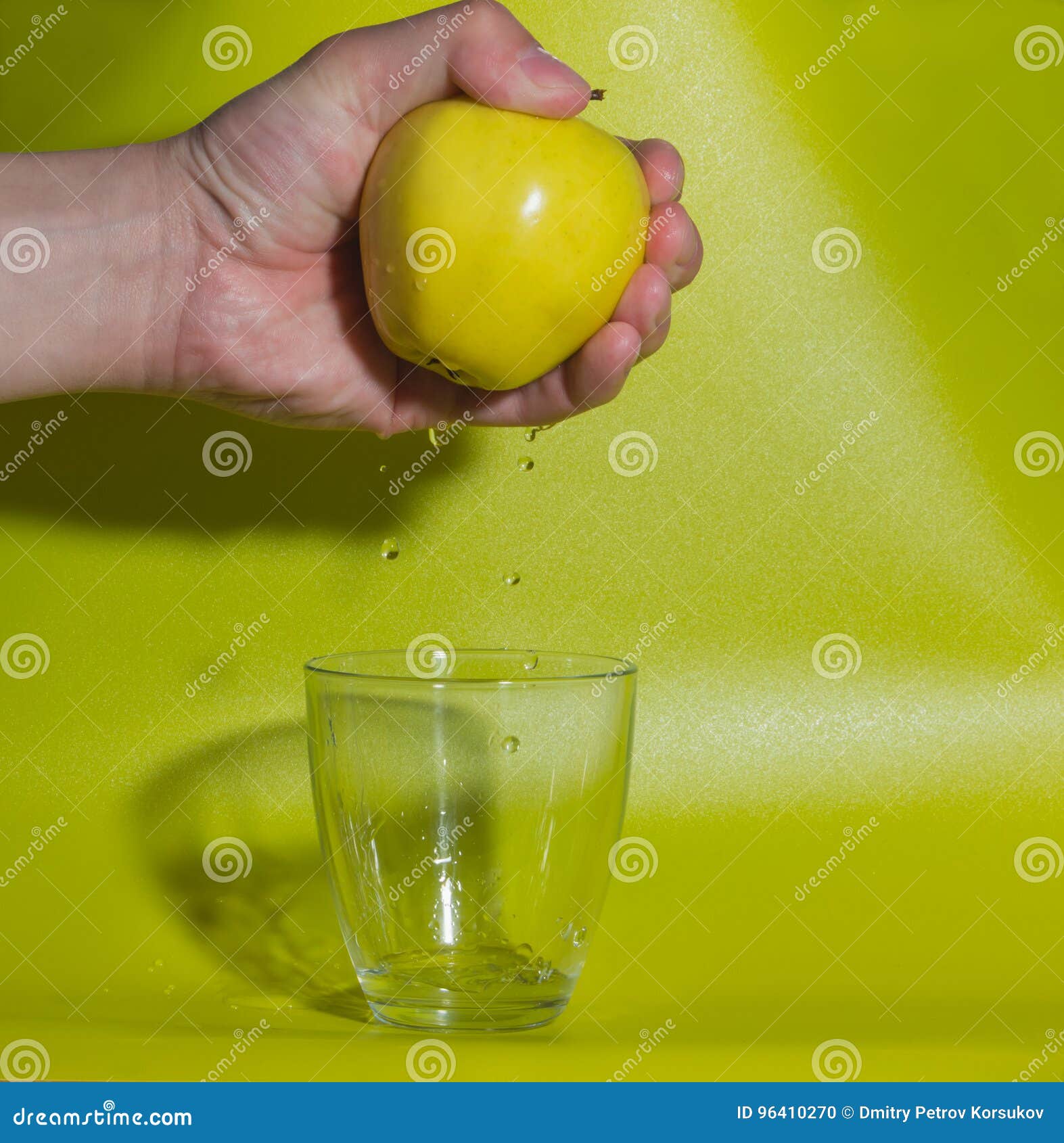 Hand with Yellow Apple, Falling Drops in a Glass of Water. Stock Photo ...