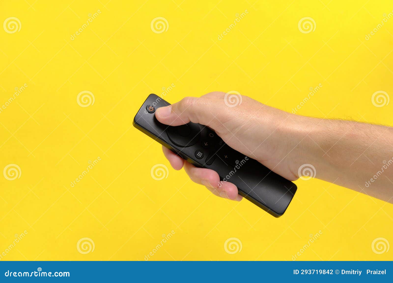Hand Yellow Background Holds TV Remote by Pressing Button with Finger ...