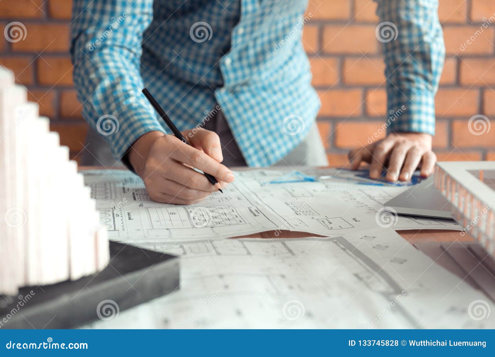 Hand of Young Engineering Man Drawing on Blueprint with Model on Stock ...