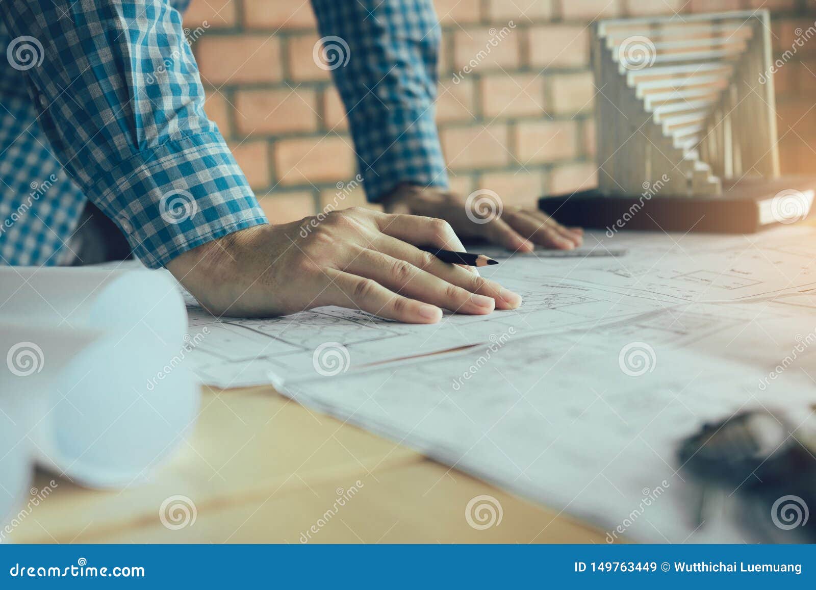 Hand of Young Engineering Man Drawing on Blueprint with Model on Desk ...
