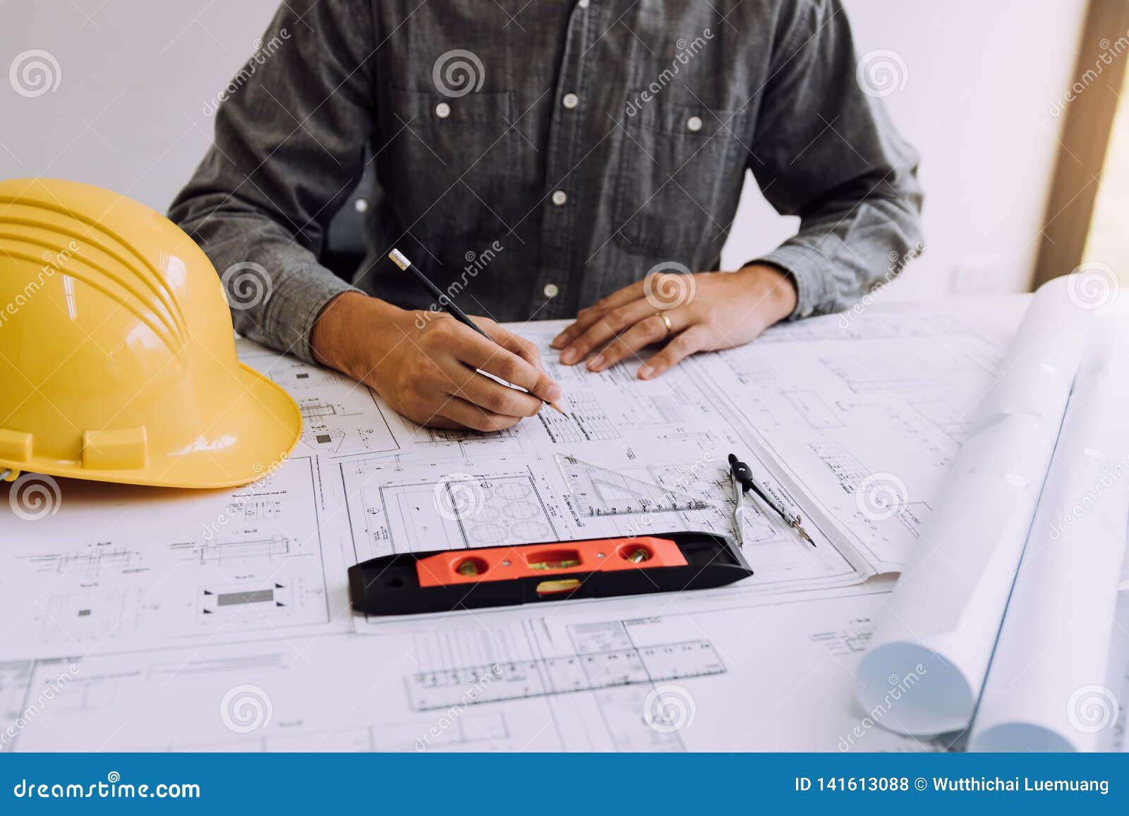Hand of Young Engineering Man Drawing on Blueprint at Table in Office ...