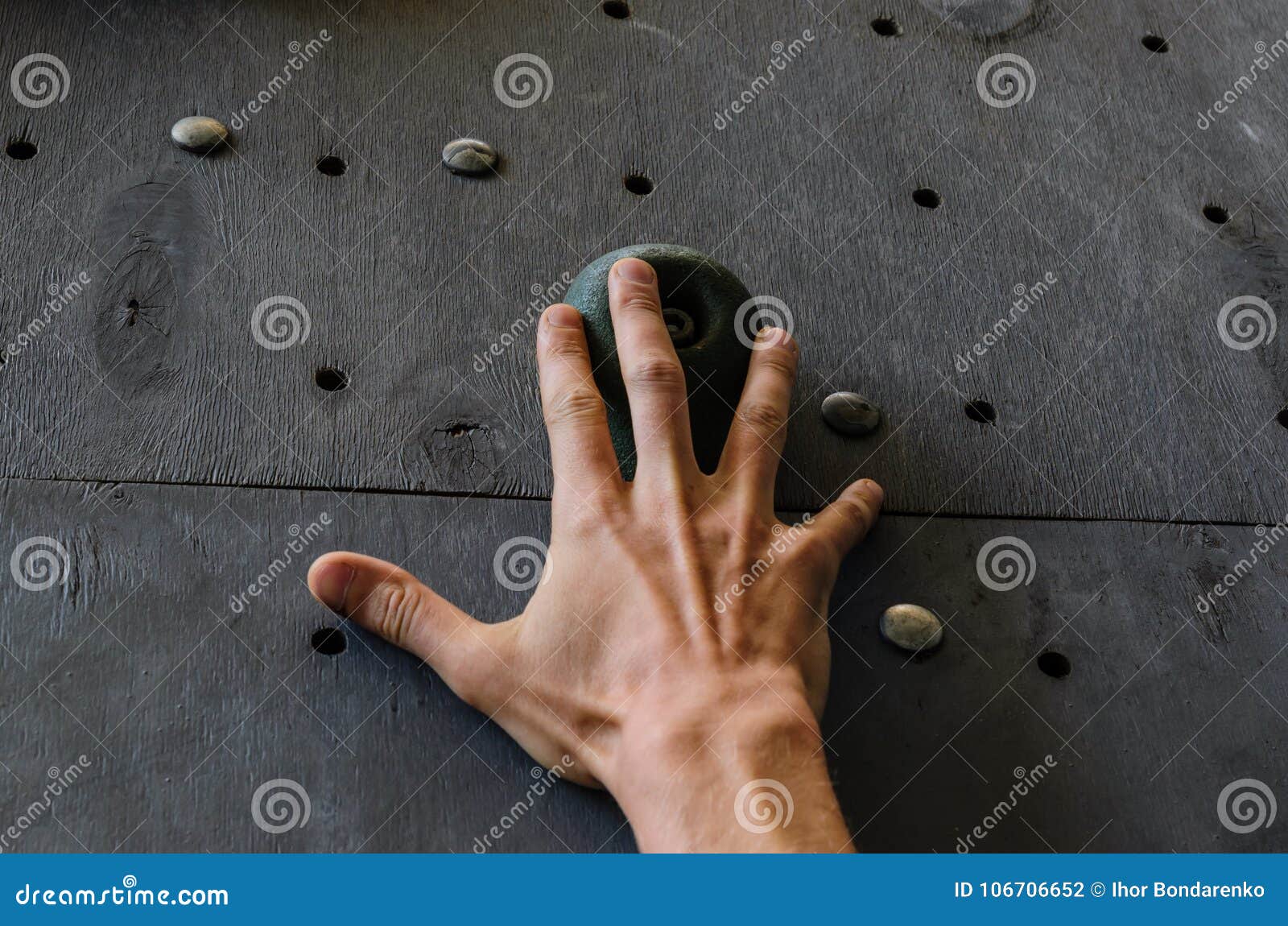 Hand of the Young Man on a Hook of the Artificial Climbing Wall Stock ...