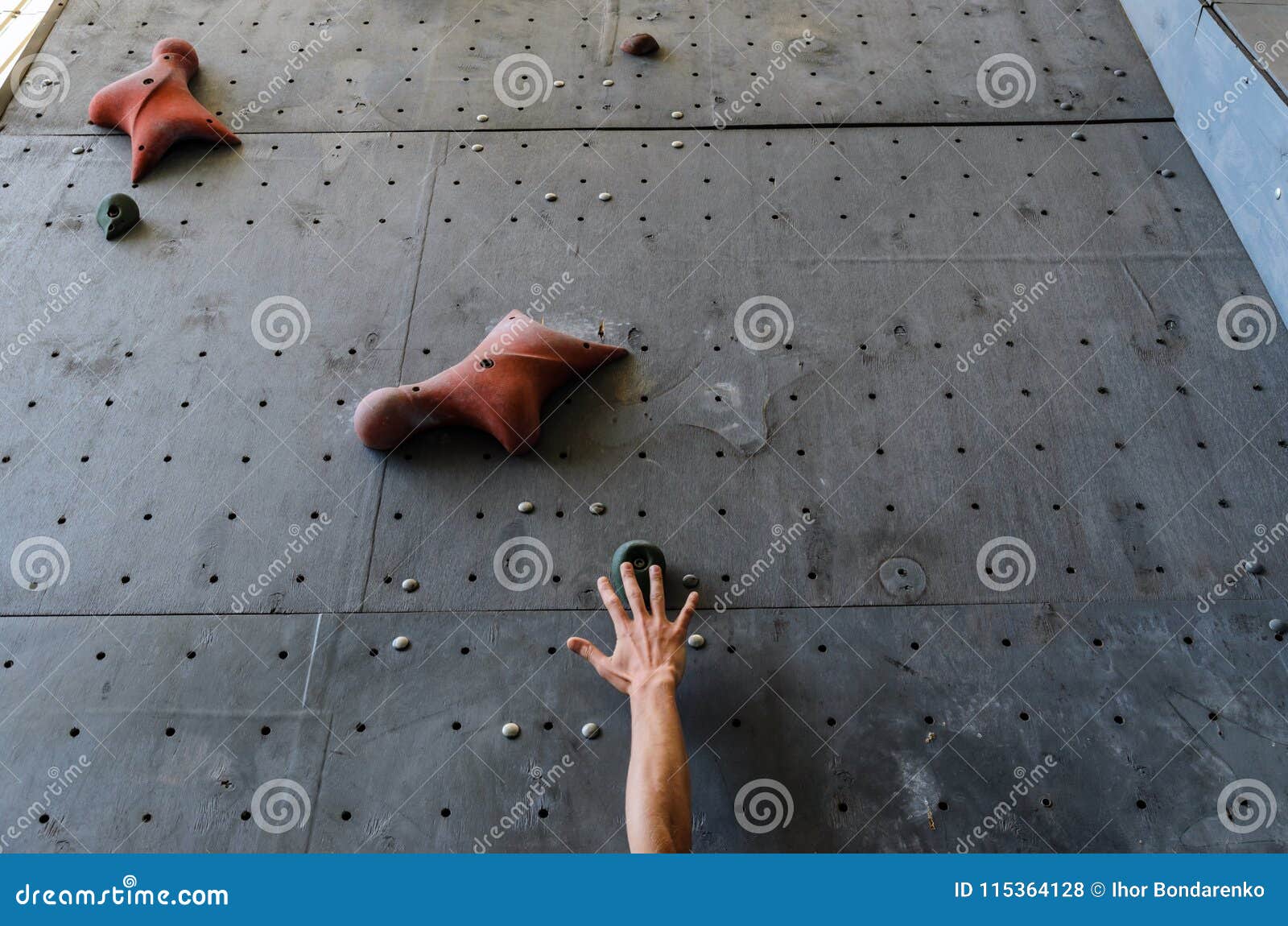 Hand of the Young Man on a Hook of the Artificial Climbing Wall Stock ...