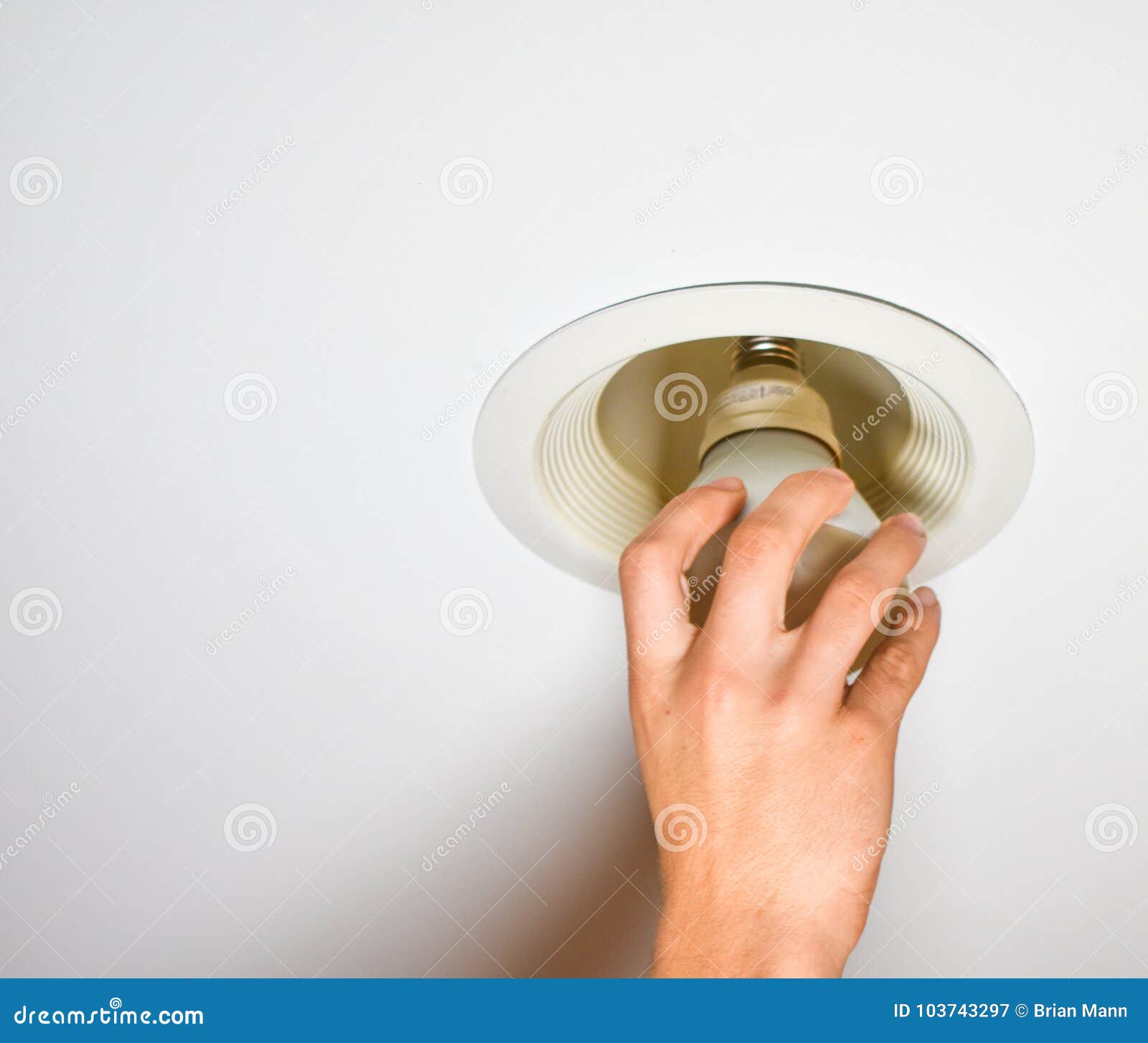 Hand of Young Man Replacing a Compact Flourescent Light Bulb Stock ...