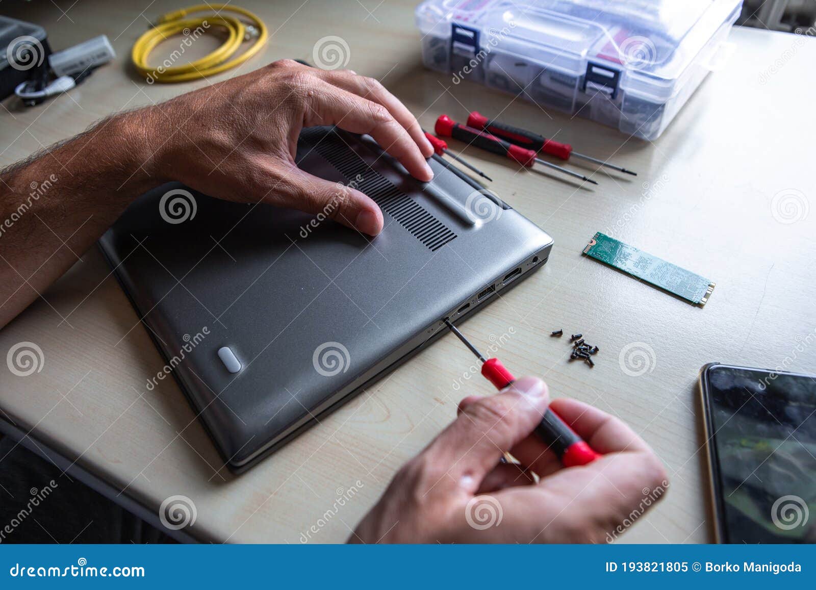 The Hand of a Young Serviceman Man Opening a Laptop Computer with a Red ...