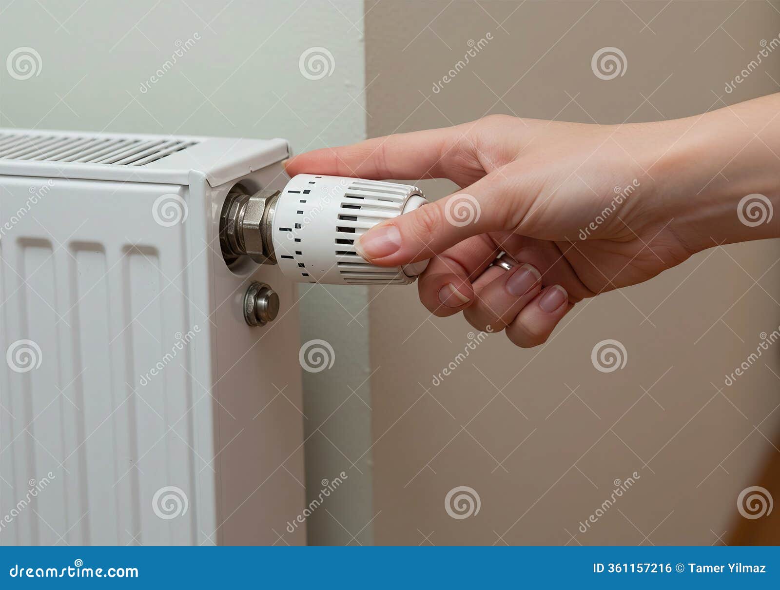 Hand of Young Woman Changing the Temperature on the Radiator by ...