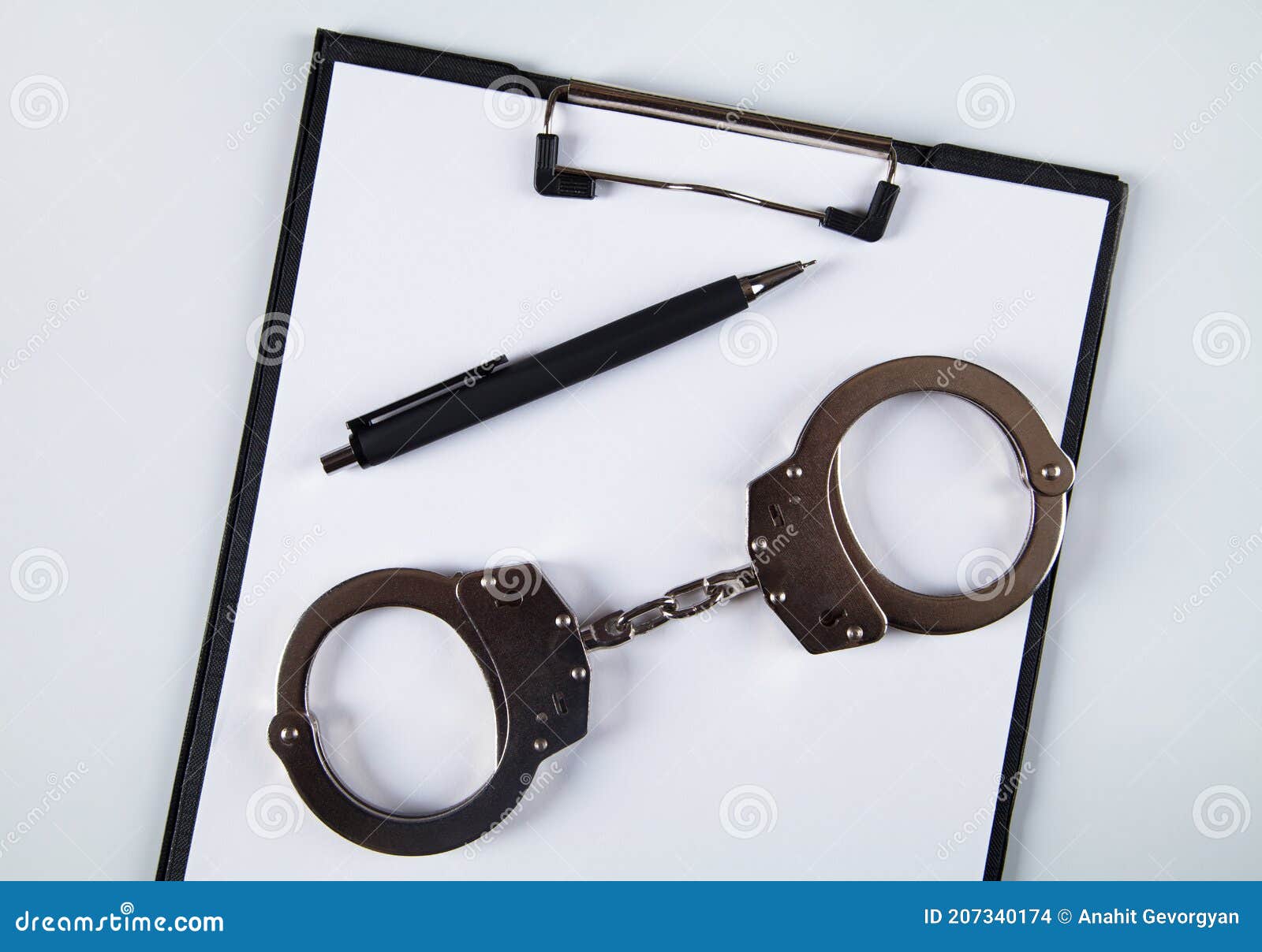 Handcuffs a Blank Sheet of Paper and a Pen on the Table Stock Photo ...