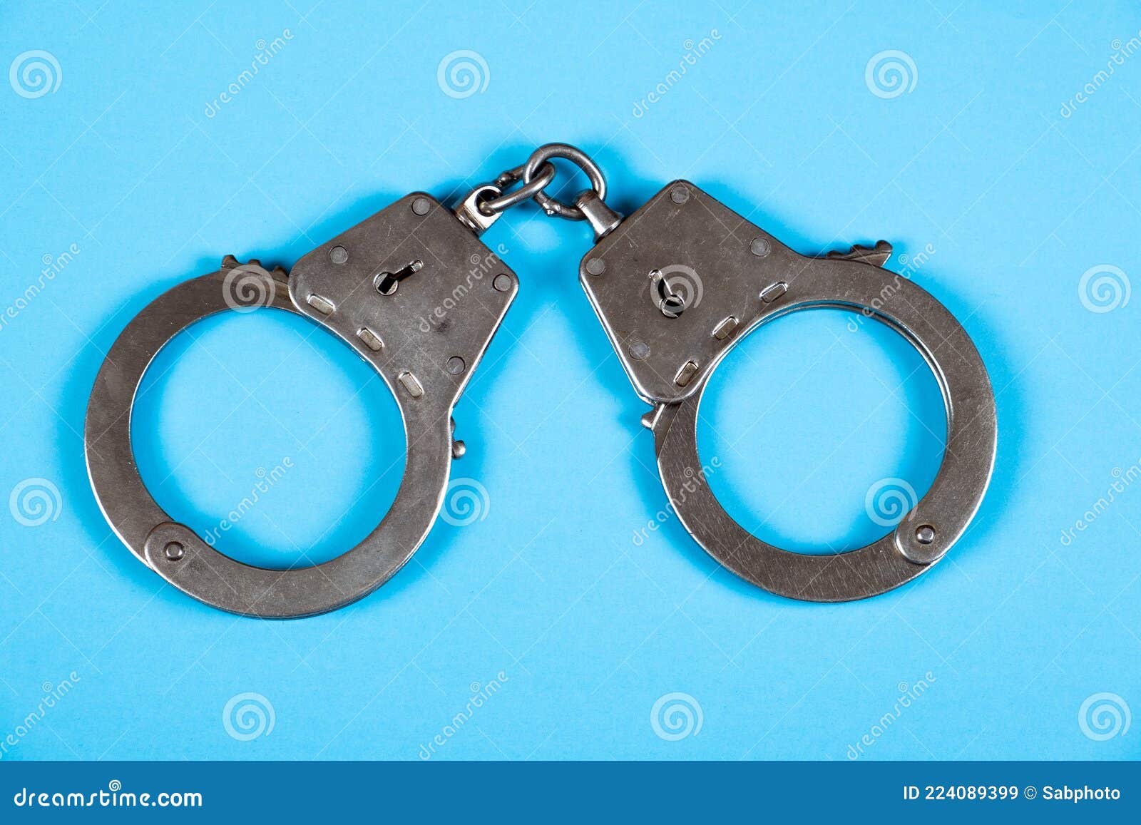 Handcuffs on the Blue Paper Stock Image - Image of desk, blue: 224089399
