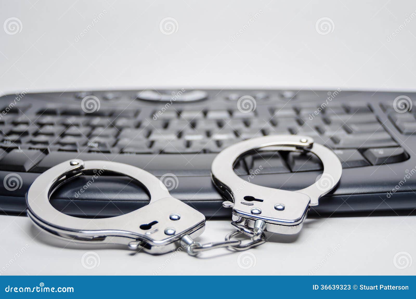 Handcuffs and Computer Keyboard Stock Image - Image of lock, hand: 36639323