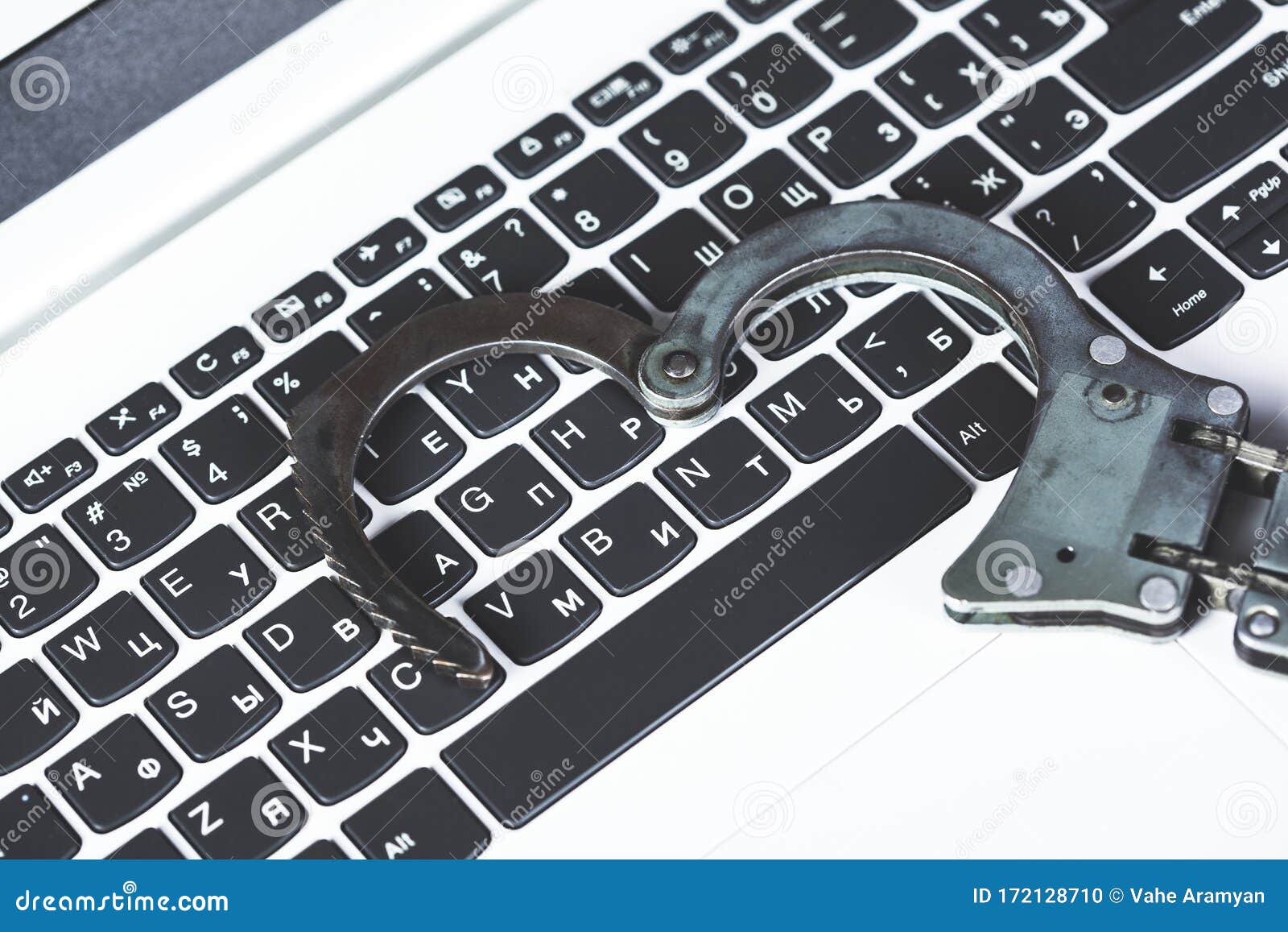 Handcuffs on Computer on Table Stock Photo - Image of keyboard, hacker ...