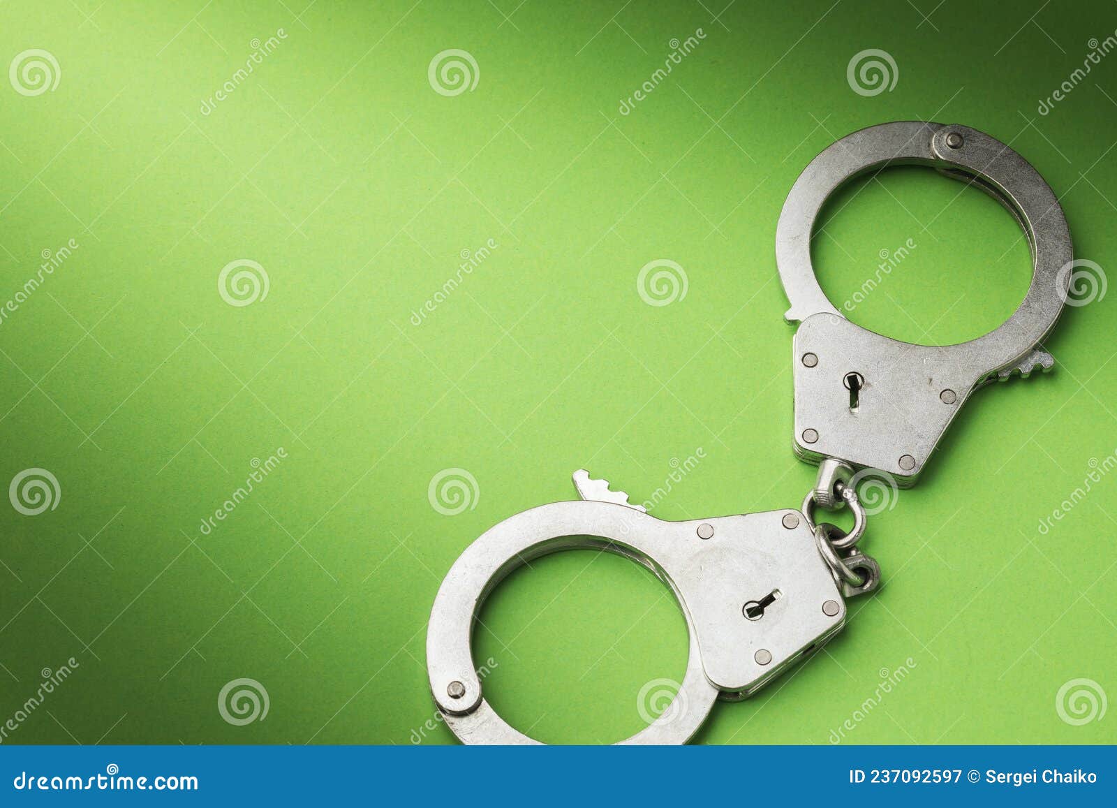 Handcuffs on a Green Background with Copy Space, Top View Stock Image ...