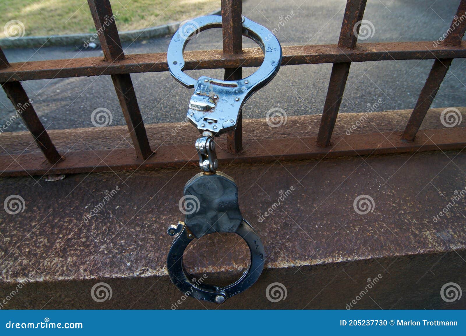 Handcuffs Hanging on a Rusty Railing Stock Photo - Image of handcuffs ...