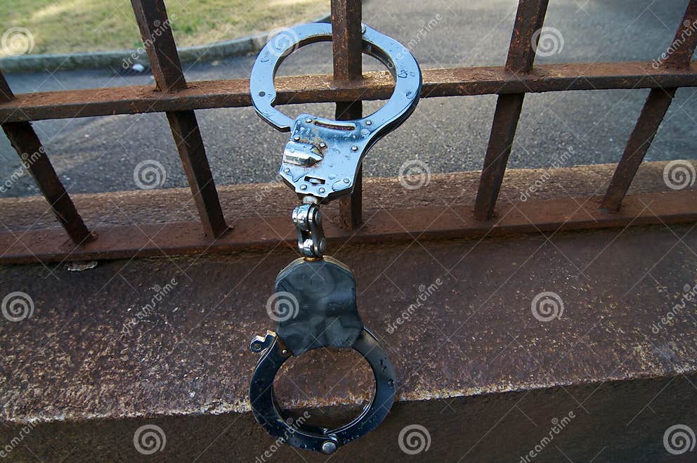 Handcuffs Hanging on a Rusty Railing Stock Photo - Image of handcuffs ...