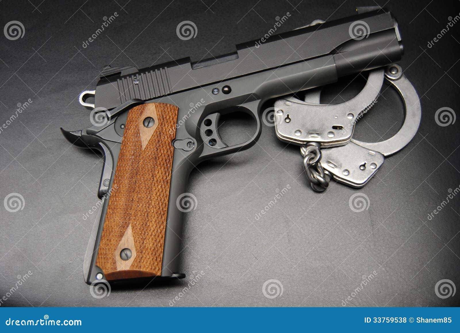 Handcuffs and 1911 Pistol stock photo. Image of pistol - 33759538