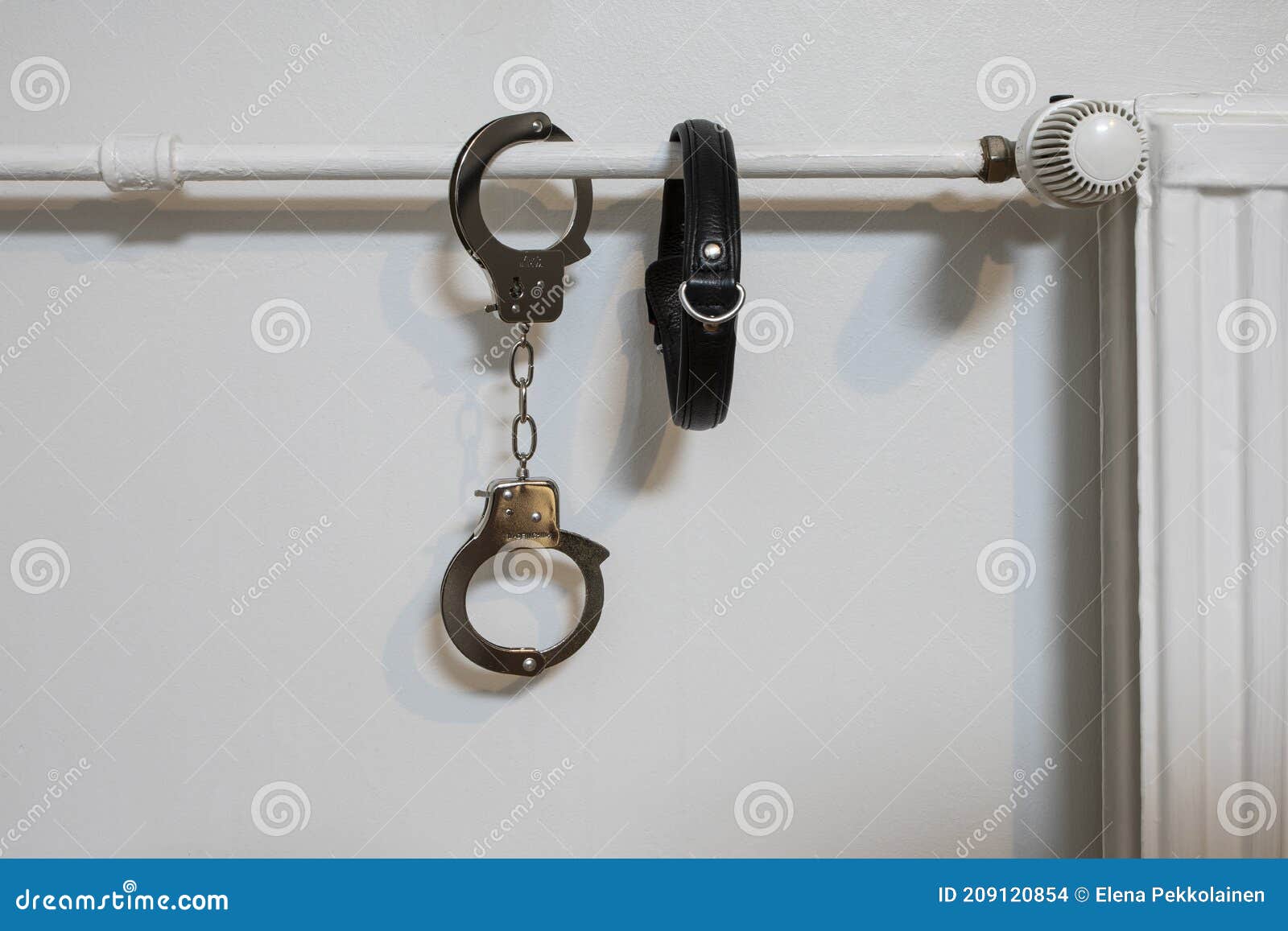 Handcuffs on the Radiator. Police Handcuffs and Collar Stock Photo ...
