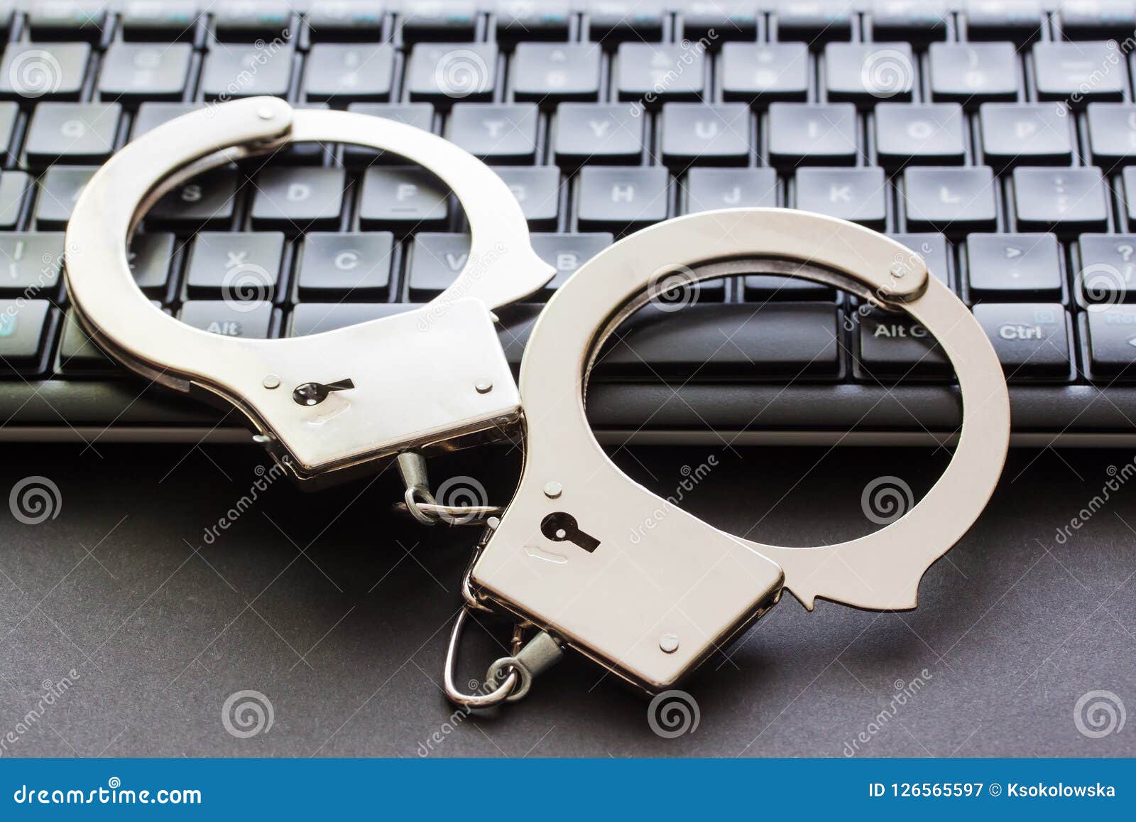 A Handcuffs Standing on Computer Keyboard. Stock Image - Image of ...