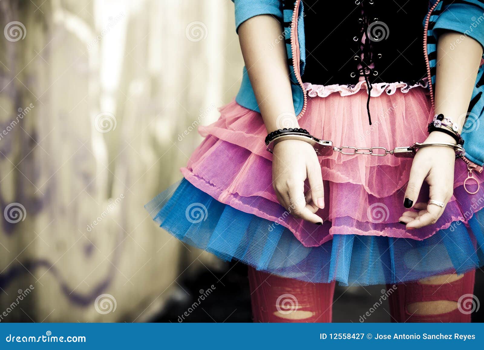 Handcuffs on young girl stock image. Image of clothing - 12558427