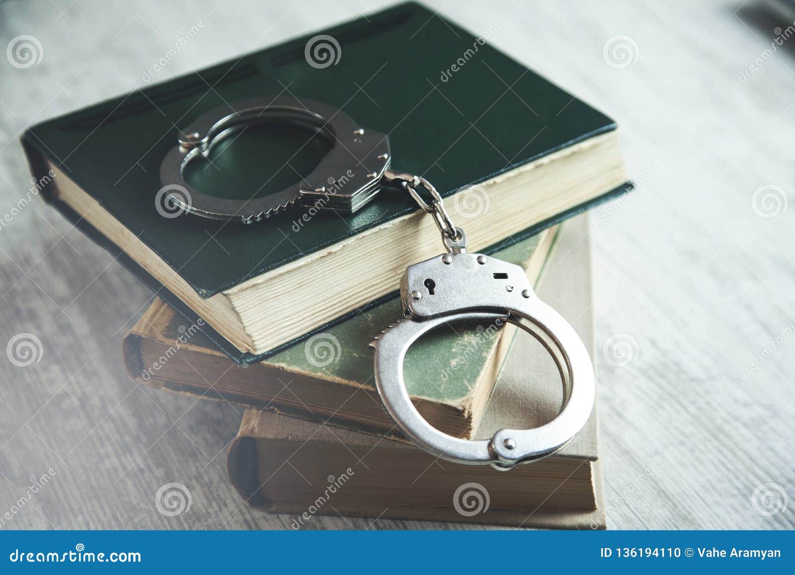 Handcuffs on books stock photo. Image of symbol, legality - 136194110