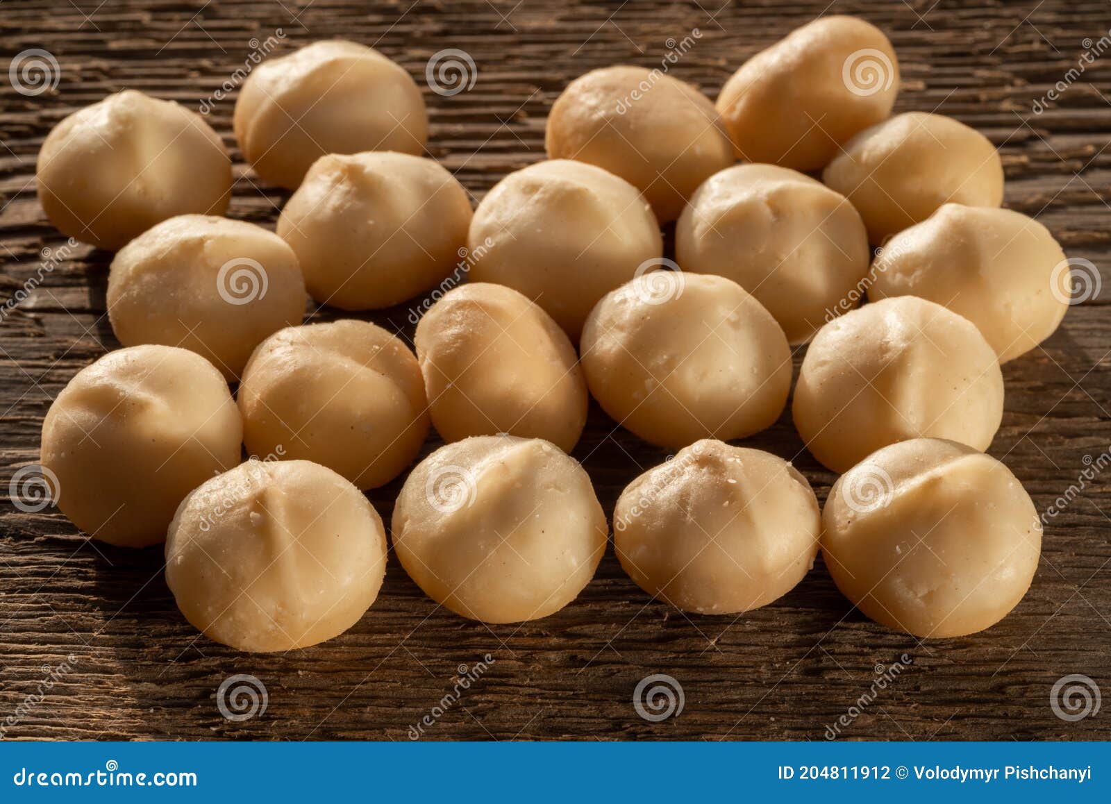 A Handful Of Kernels Of Macadamia Nuts On The Wood Texture Stock ...