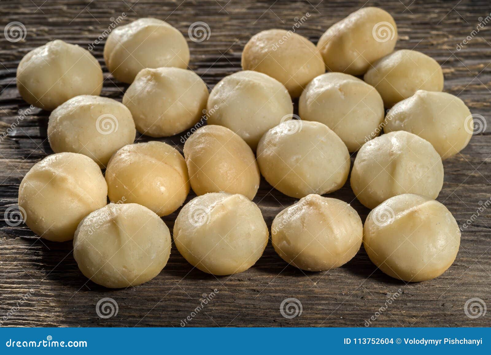 A Handful Of Kernels Of Macadamia Nuts On The Wood Texture Stock ...