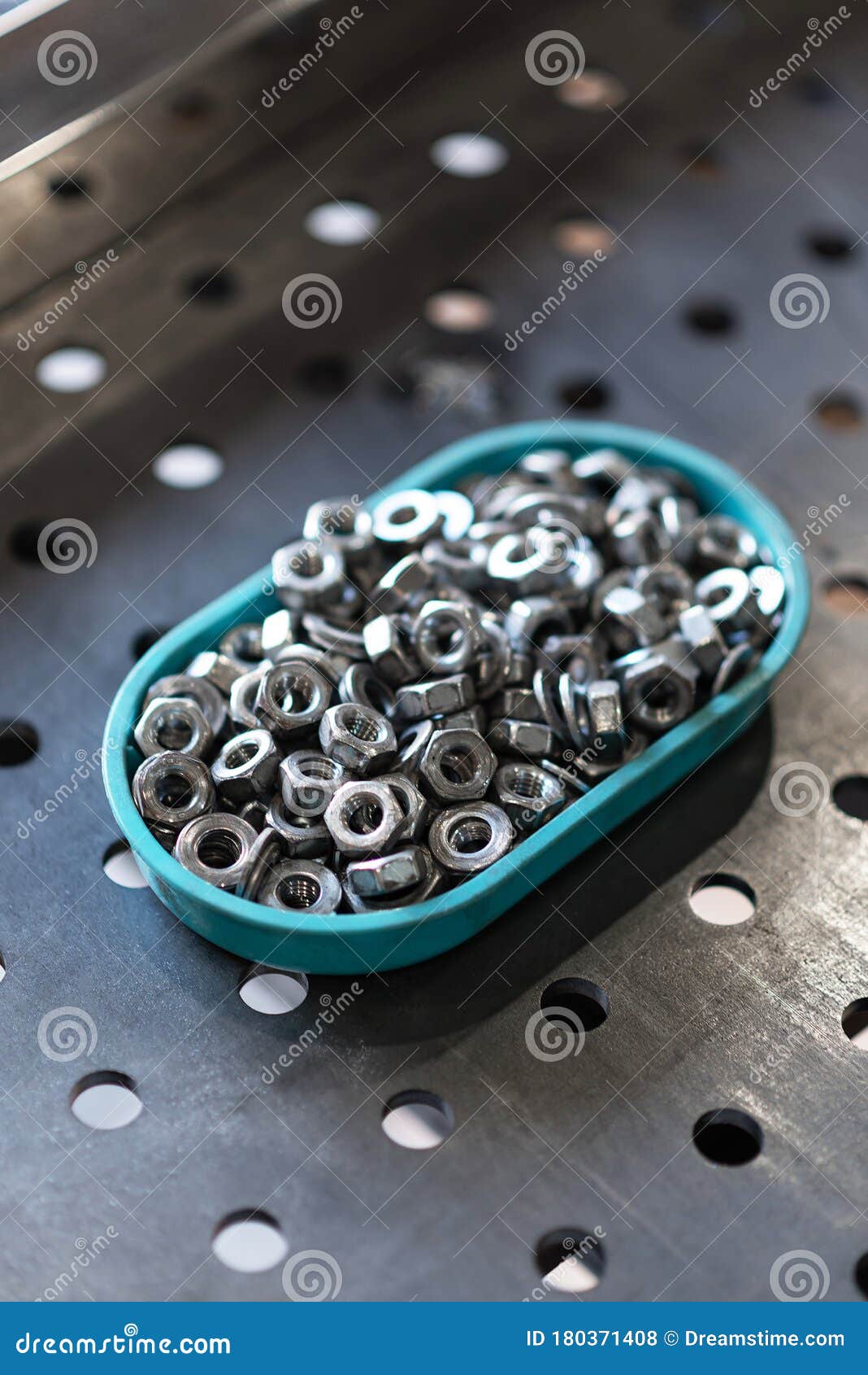 A Handful of Metal Nuts in a Plastic Container for Storage Stock Photo ...
