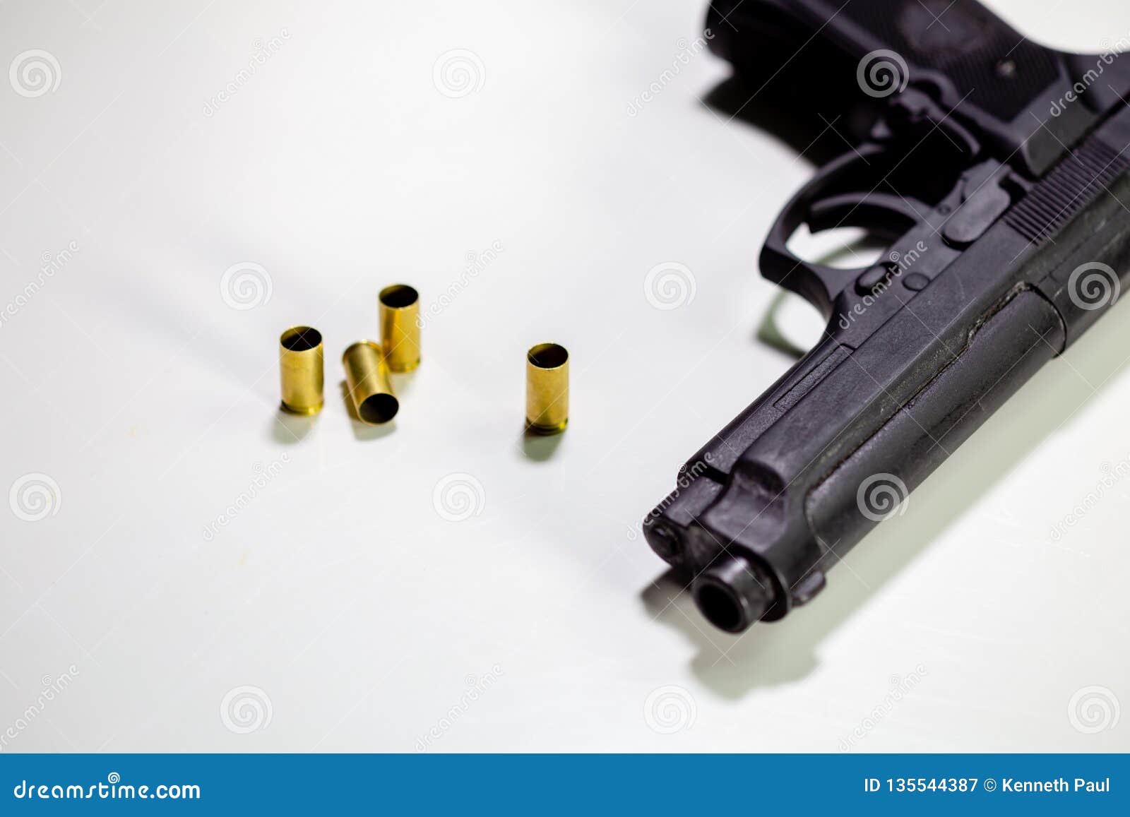 Handgun with 9mm Shell Casings on White Table Stock Image - Image of ...