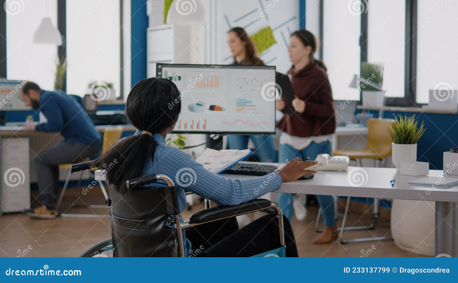 Handicapped African Worker Comparing Graphics from Clipboard and ...
