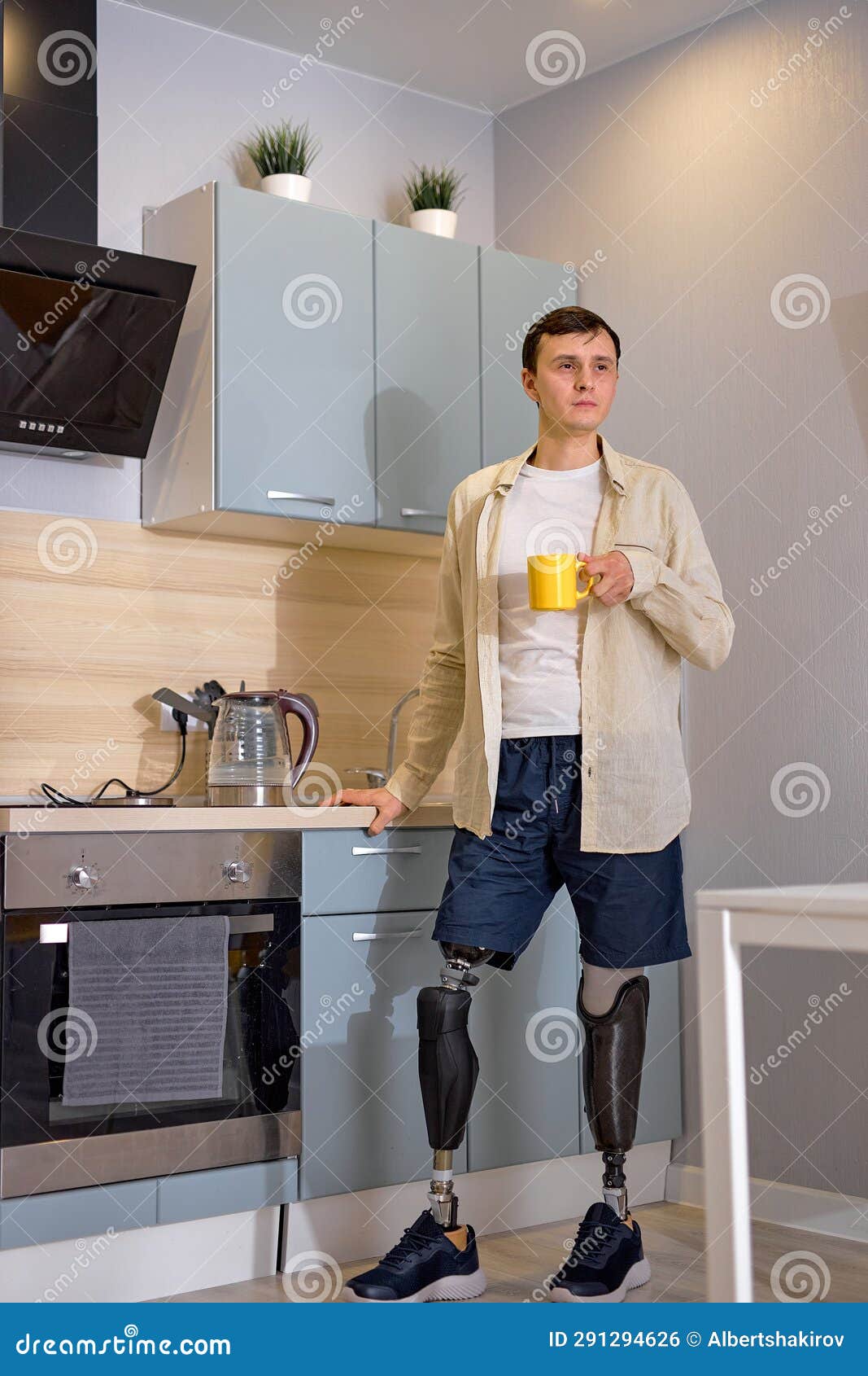 Handicapped Man Stand in Artificial Fake Legs Drinking Coffee or Tea in ...