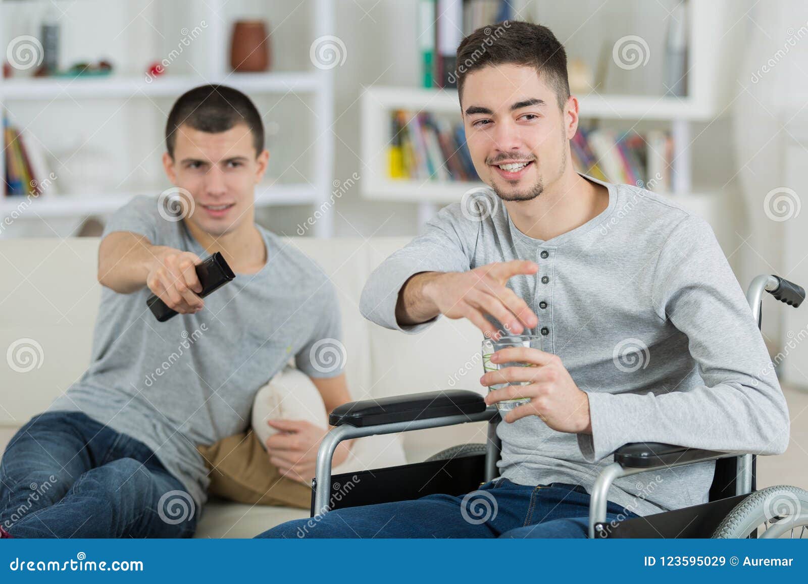 Handicapped Man Using Remote Control while Watching Tv Stock Image ...