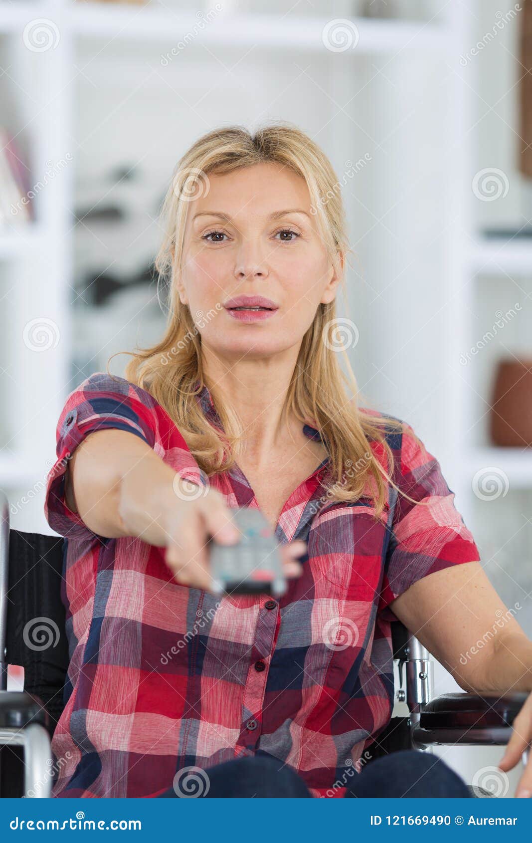 Handicapped Woman Using Remote Control while Watching Television Stock ... Handicapped Woman Using Remote Control while Watching Television Stock ...