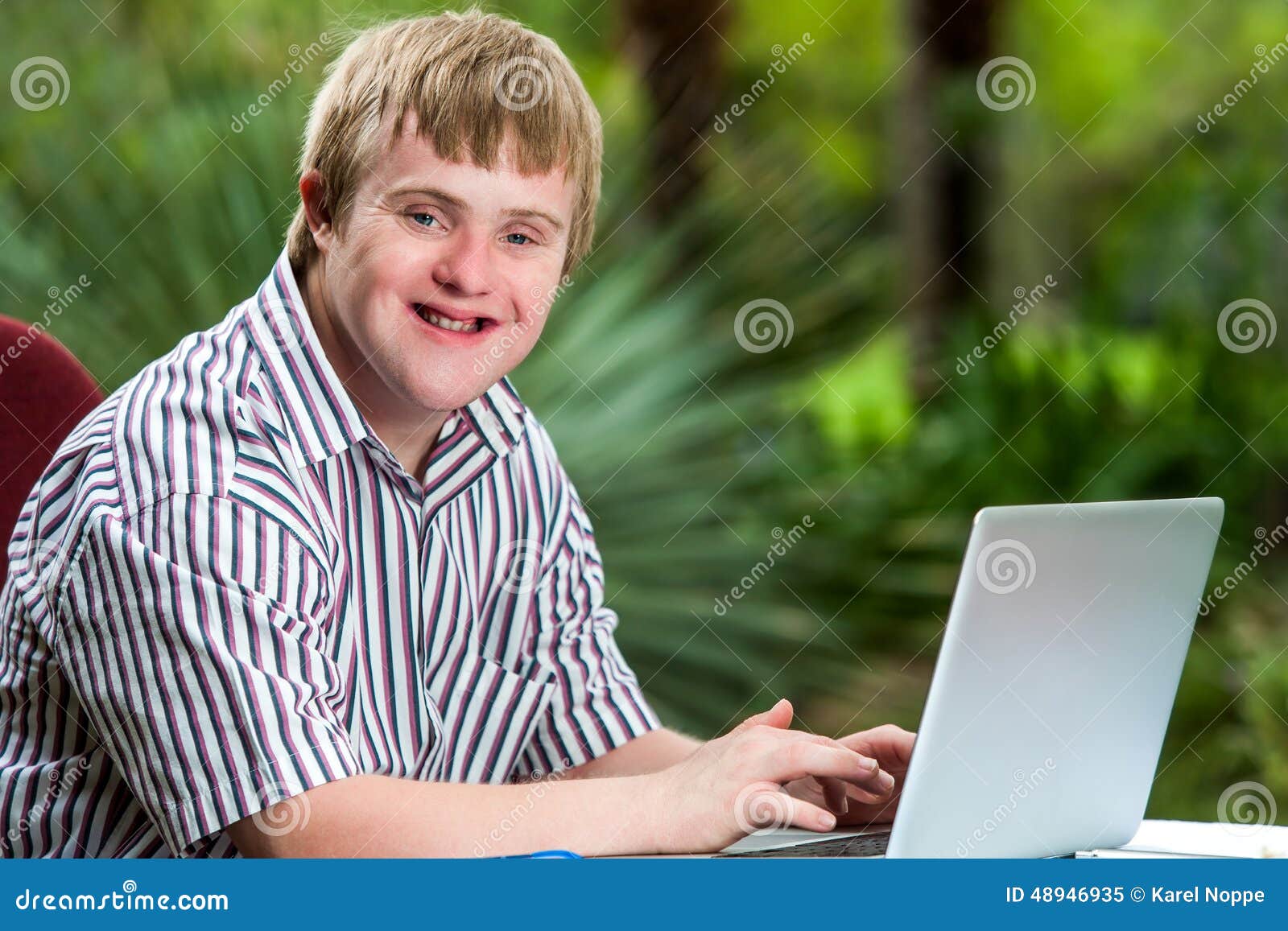Handicapped Young Man Typing on Laptop in Garden. Stock Image - Image ... Handicapped Young Man Typing on Laptop in Garden. Stock Image - Image ...