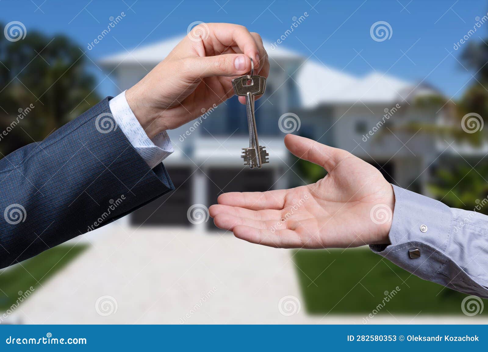 Handing Over the House Keys in Front of a Beautiful New Home. Stock ...