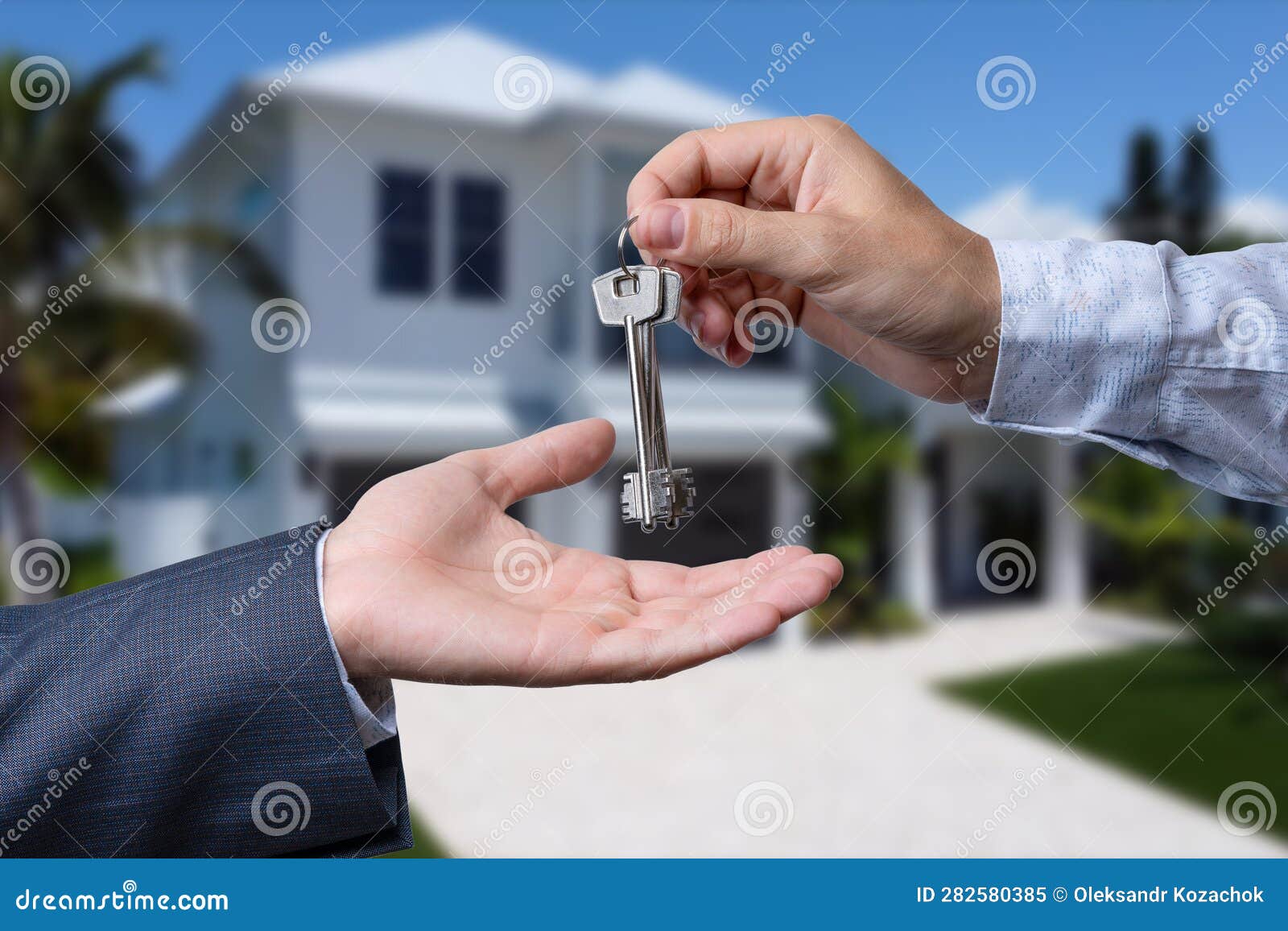 Handing Over the House Keys in Front of a Beautiful New Home. Stock ...
