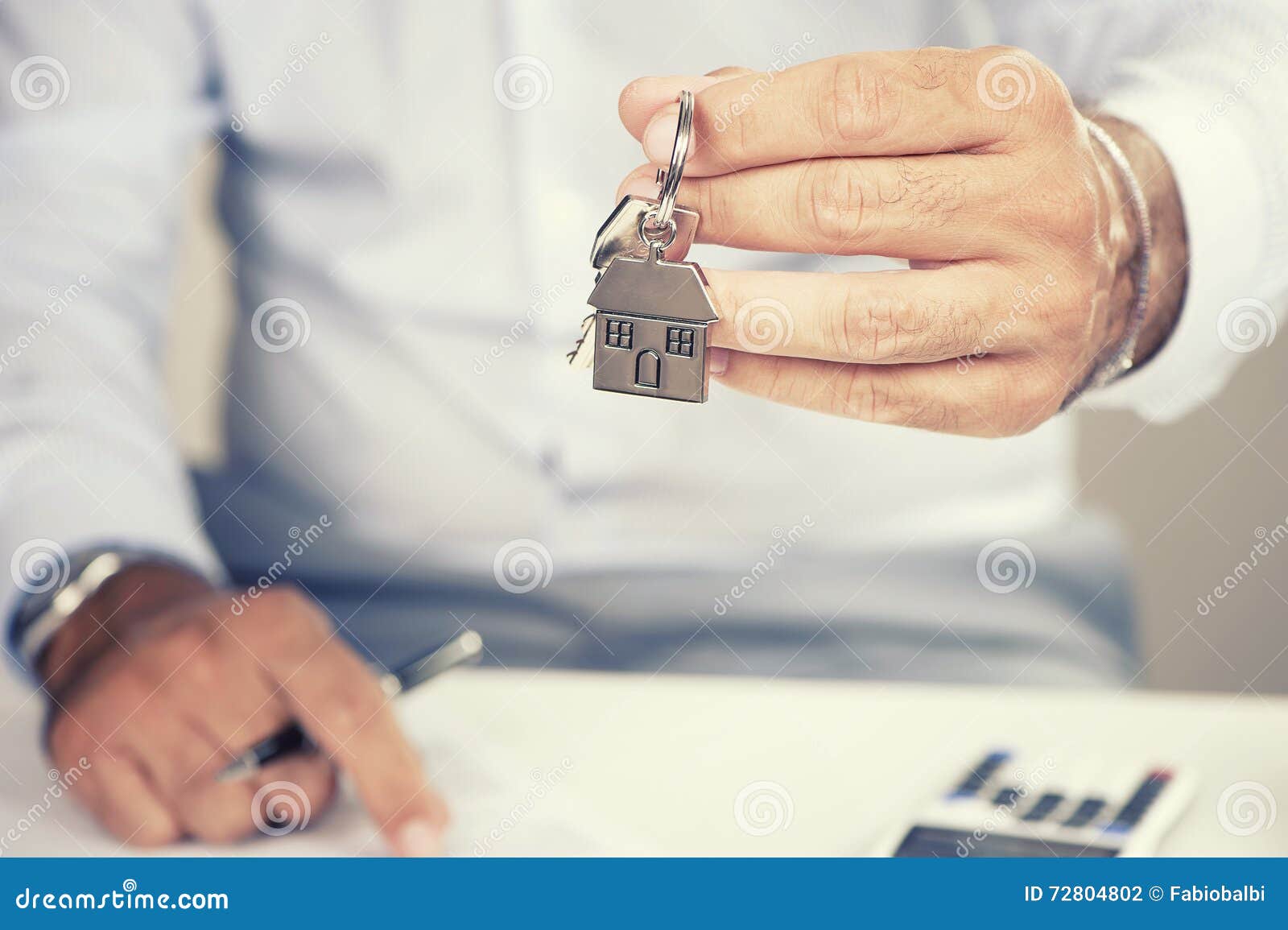Handing over house keys stock photo. Image of finance - 72804802