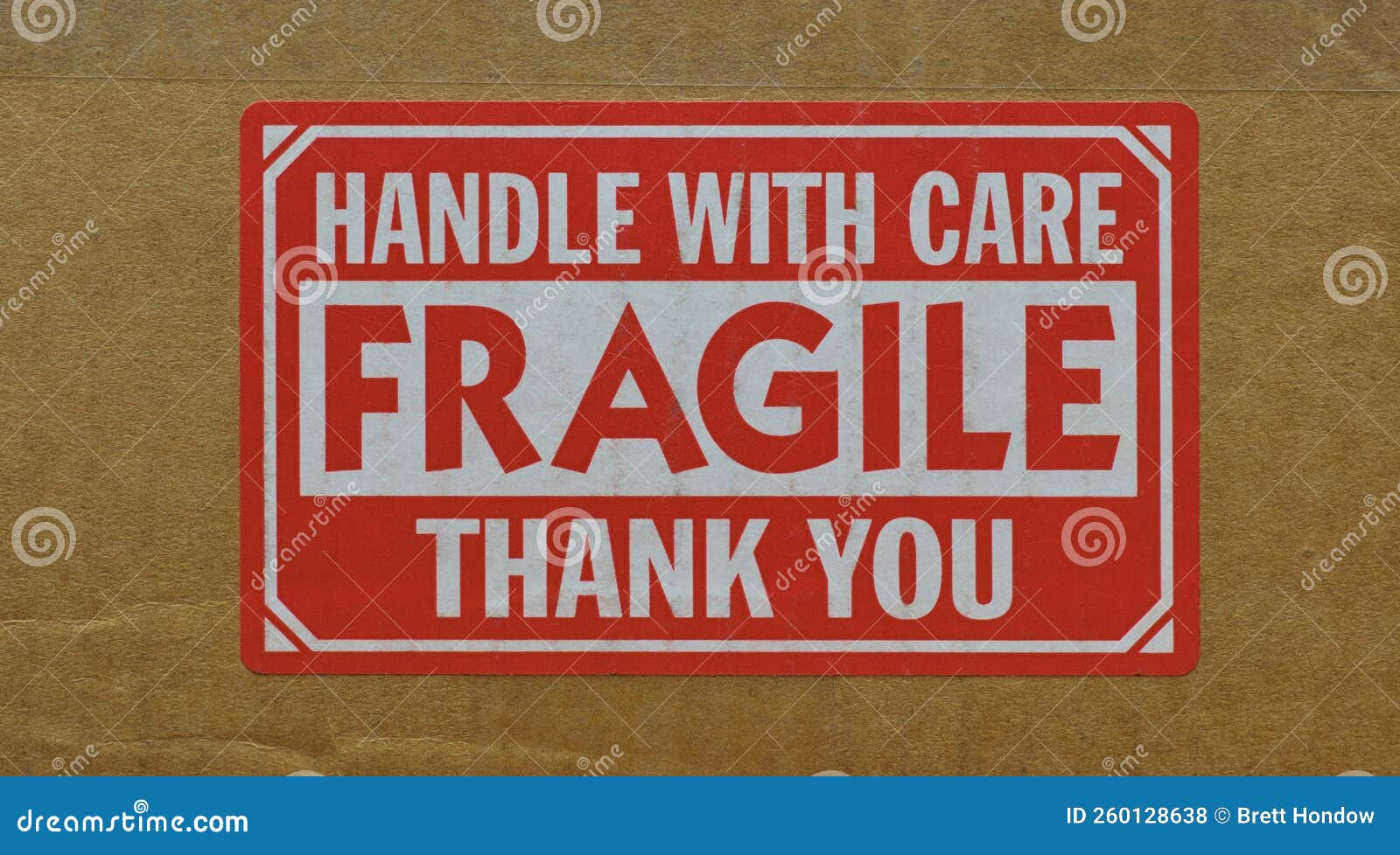 Handle with Care Sticker Attached To the Side of a Cardboard Box. Stock ...