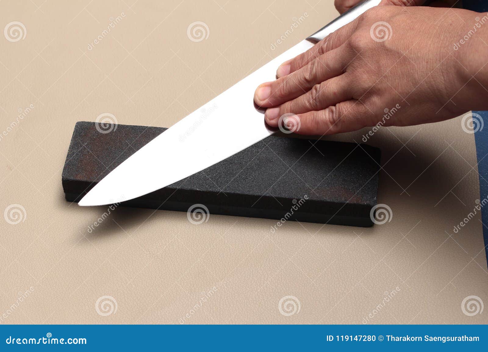 Handle the Knife To Make a Sharp Knife with a Whetstone. Stock Photo ...