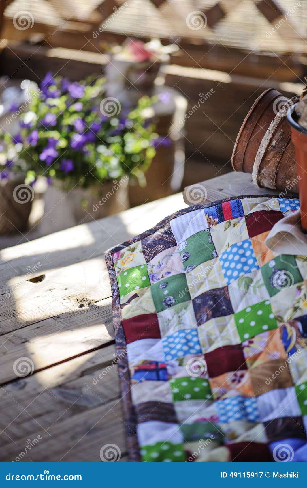 Handmade Patchwork Blanket on Wooden Table with Spring Flowers on ...