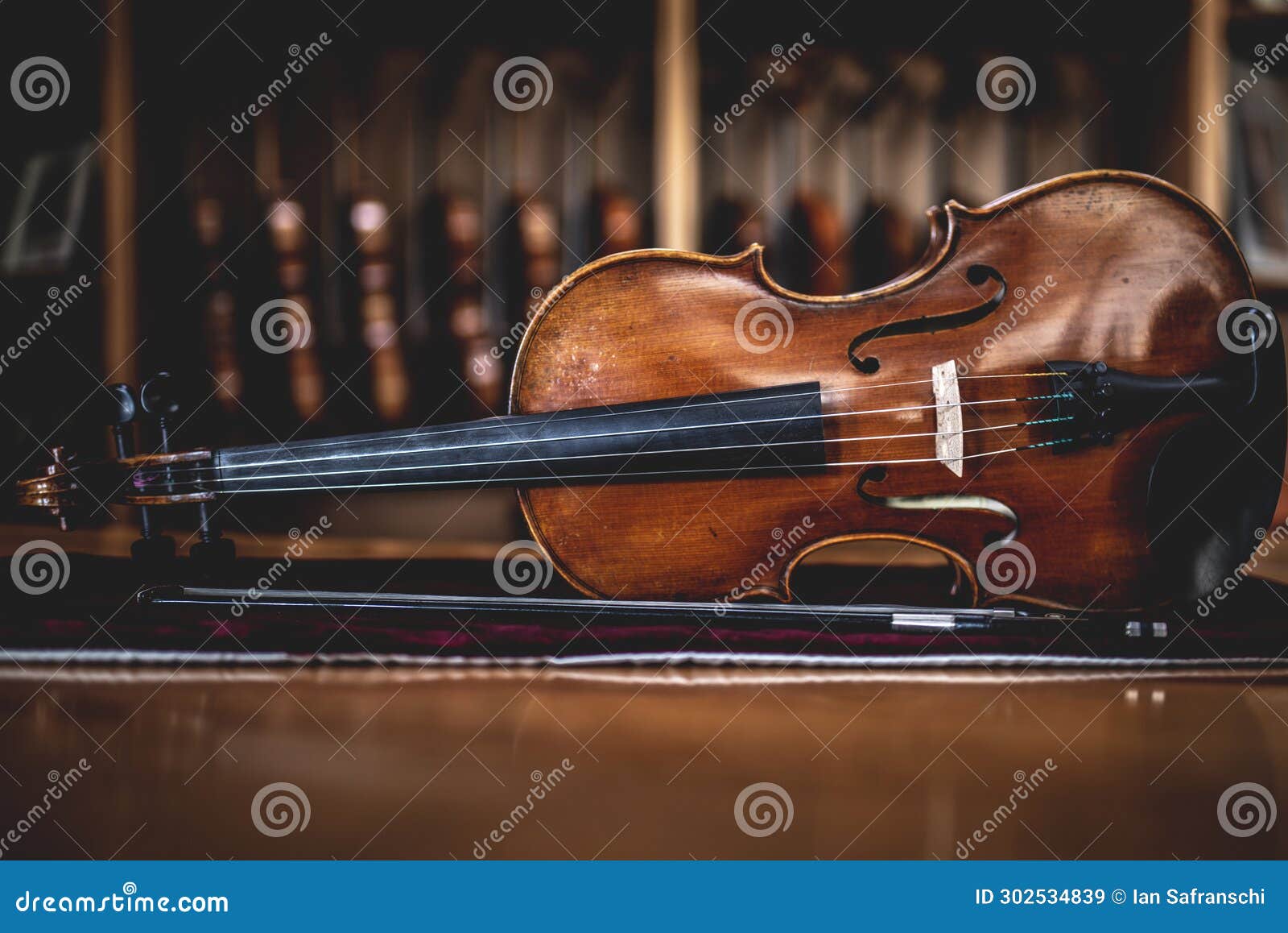 Handmade Viola Leaning Sideways with a Row of Violins on the Background ...
