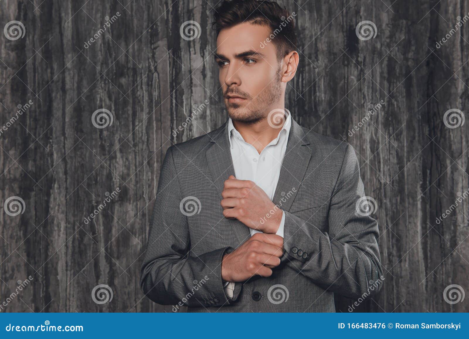 Handome Man in Gray Suit Fastening Buttons on the Sleeves Stock Photo ...