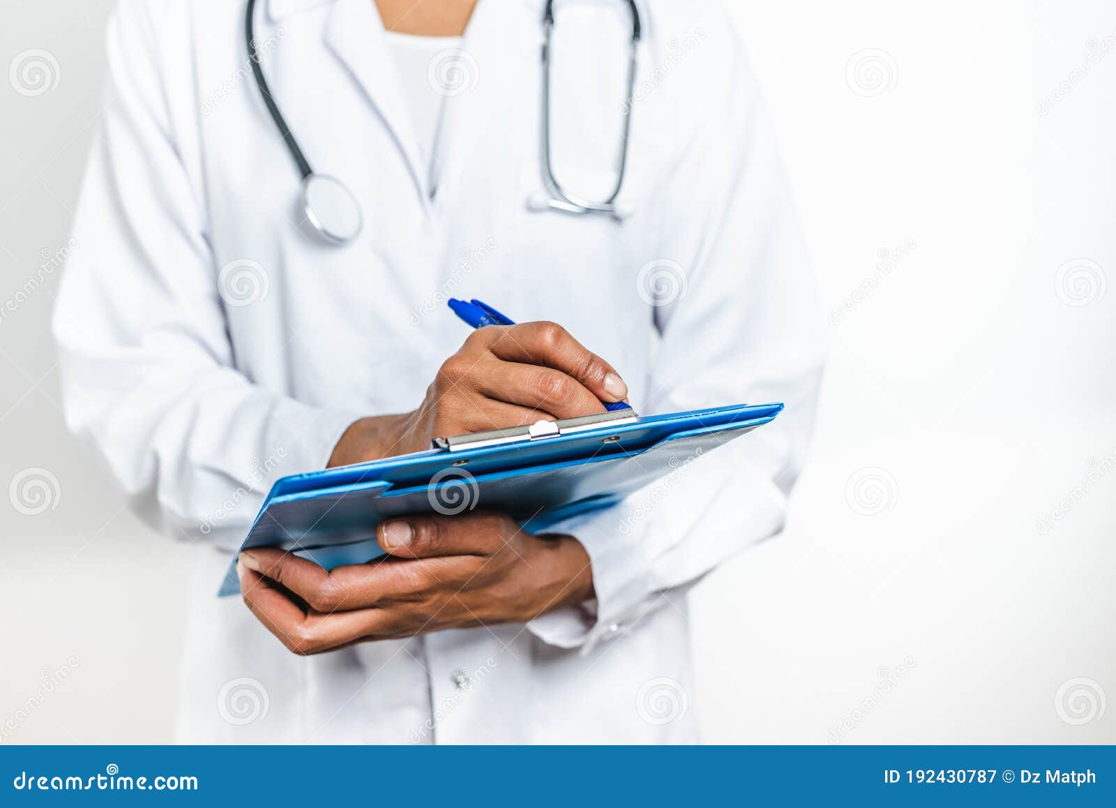 Hands of an Afro Female Doctor Writing on a Paper with the Help of a ...