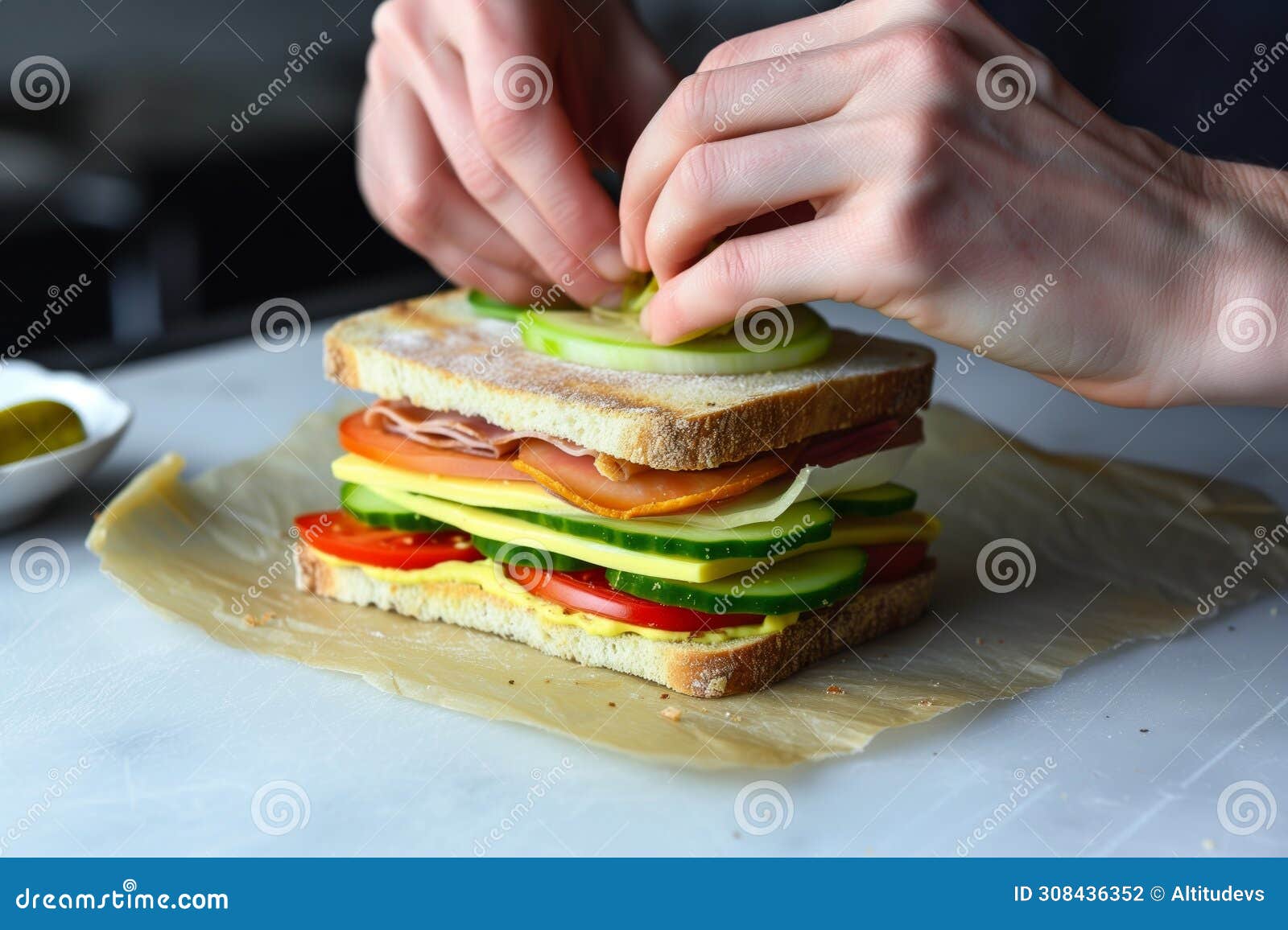 Hands Assembling a Sandwich with Layers Visible Stock Photo - Image of ...