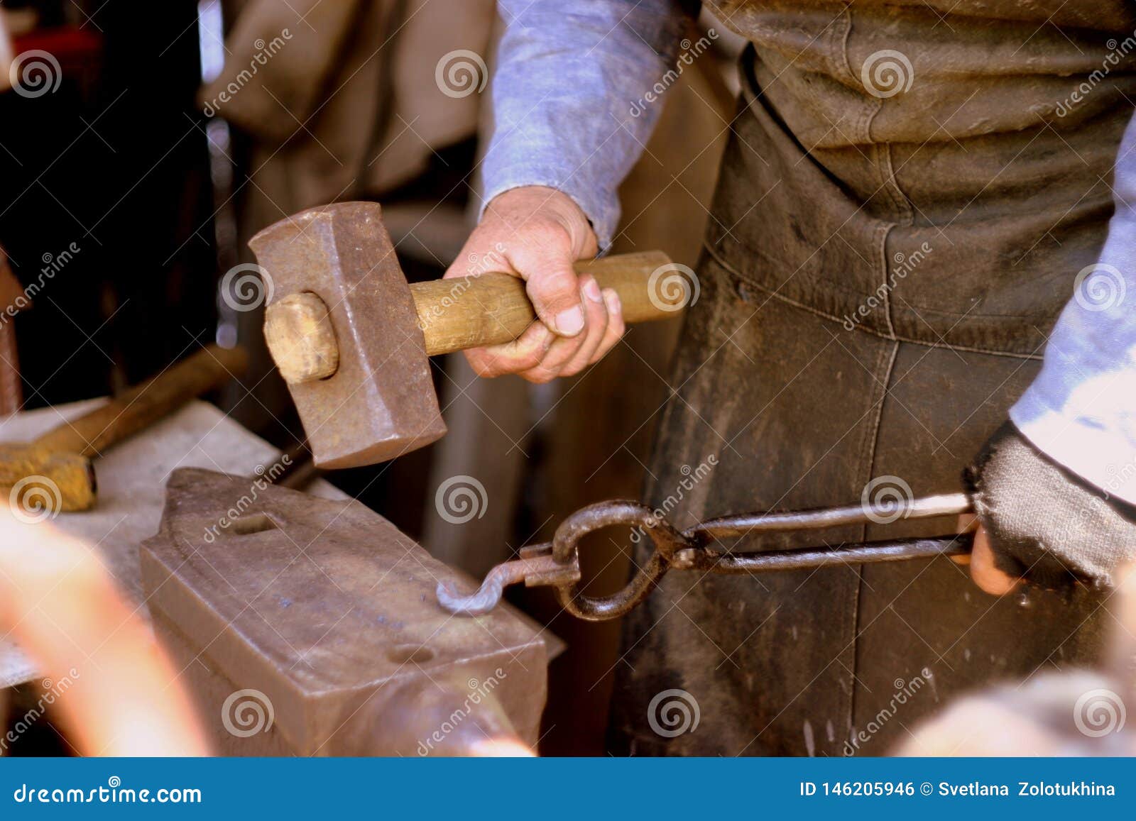 Hands of a Blacksmith Artisan with a Hammer. Stock Photo - Image of ...